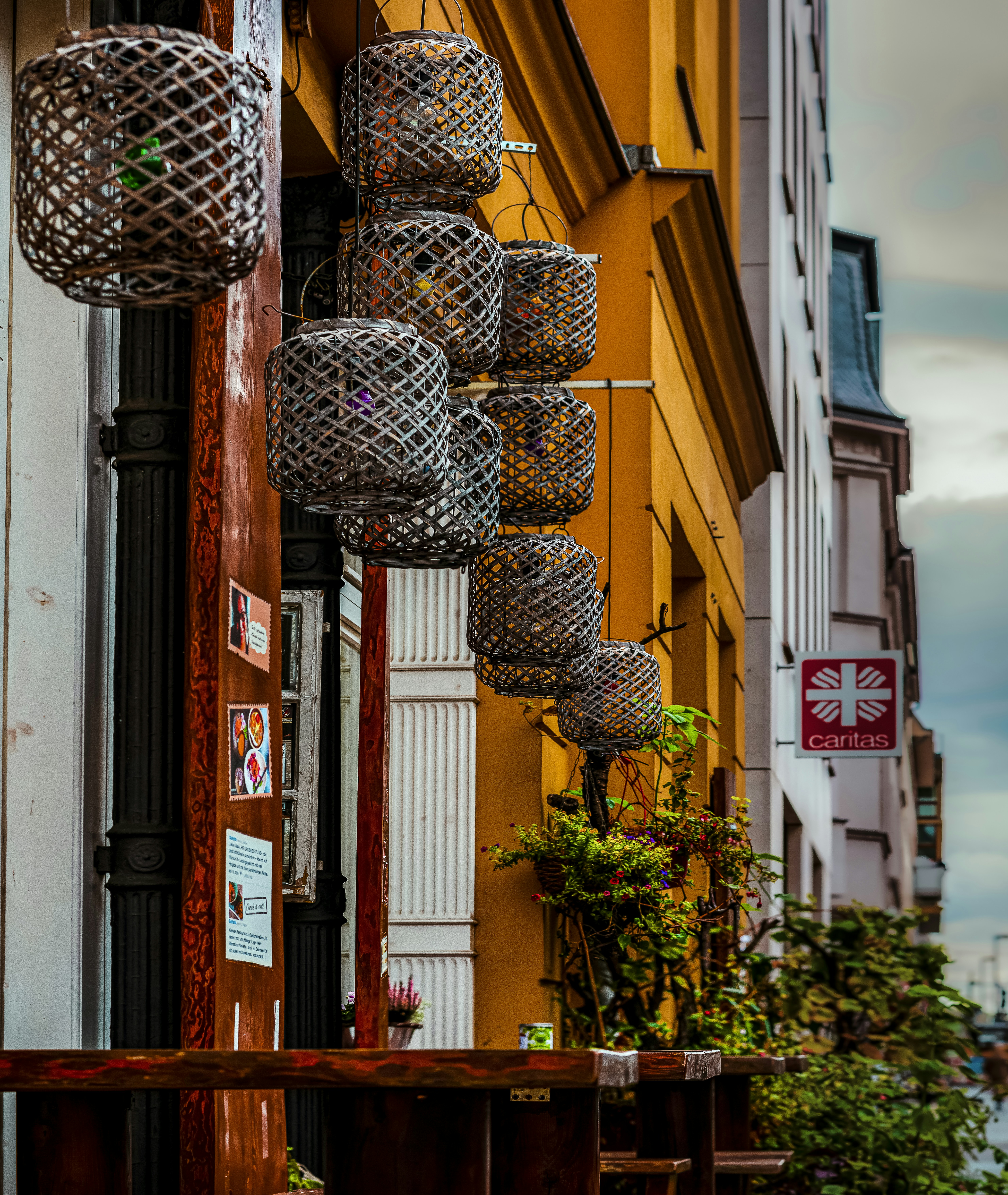 Lattice Lanterns Along a Sun-Warmed Yellow Facade