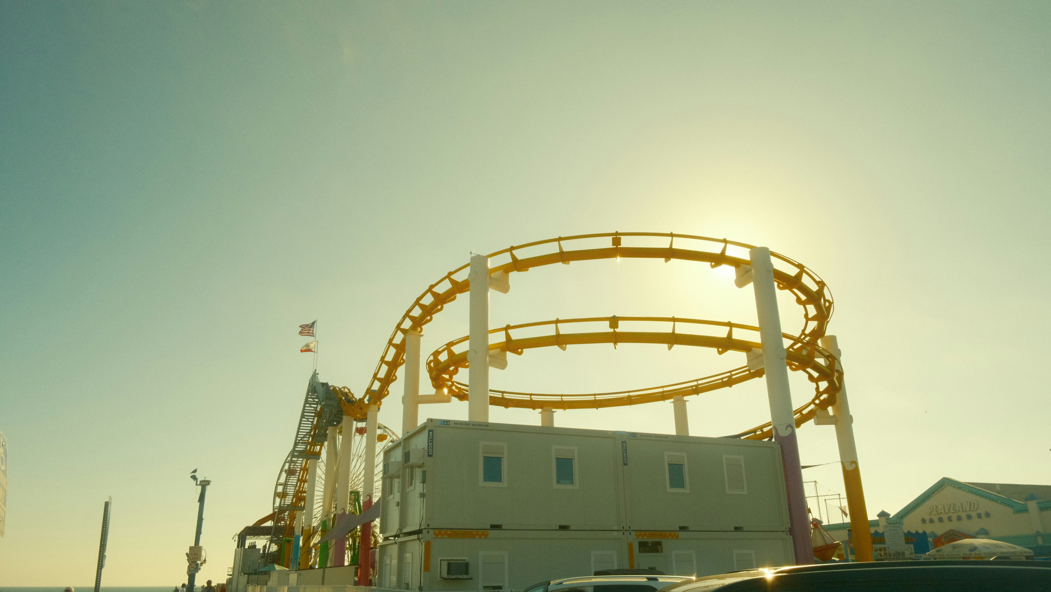A roller coaster on a beach near the ocean photo – Free California ...