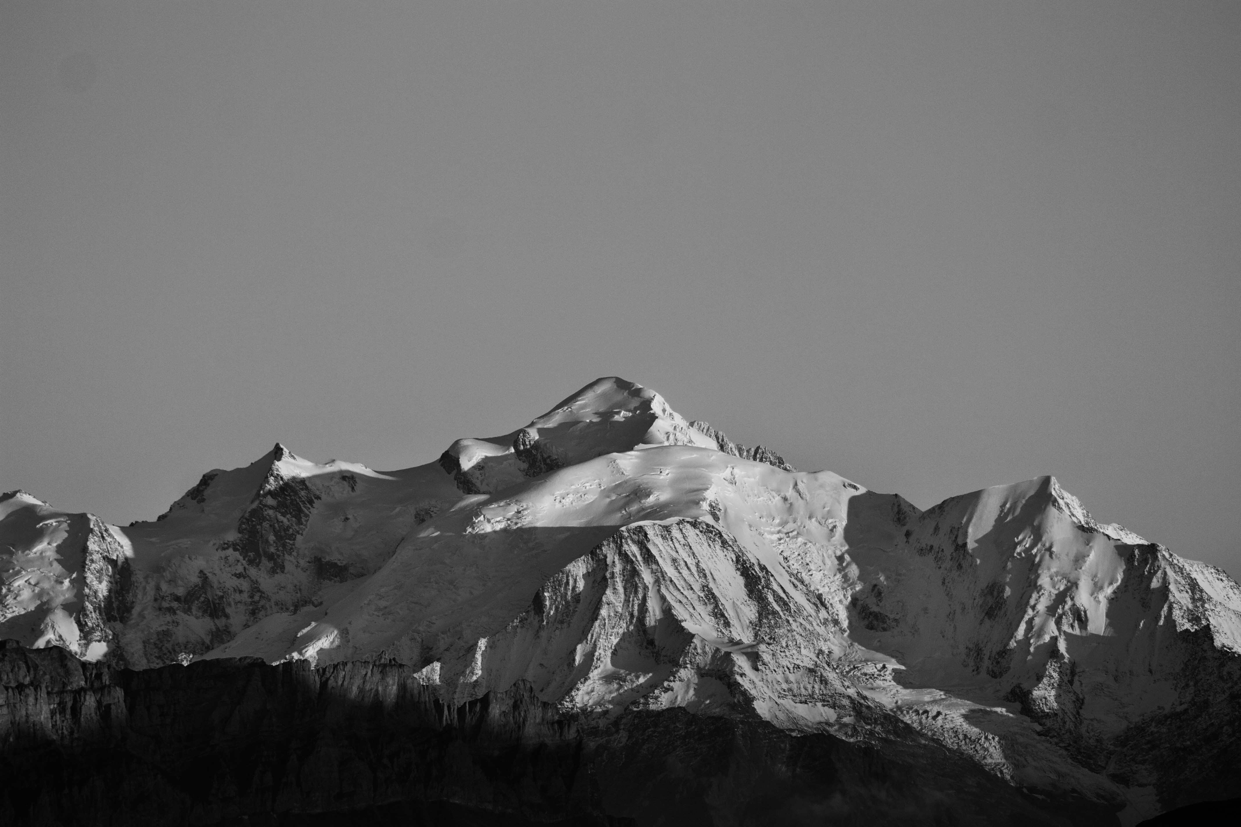 Snow-covered peaks of Mont Blanc under contrasting light and shadow.