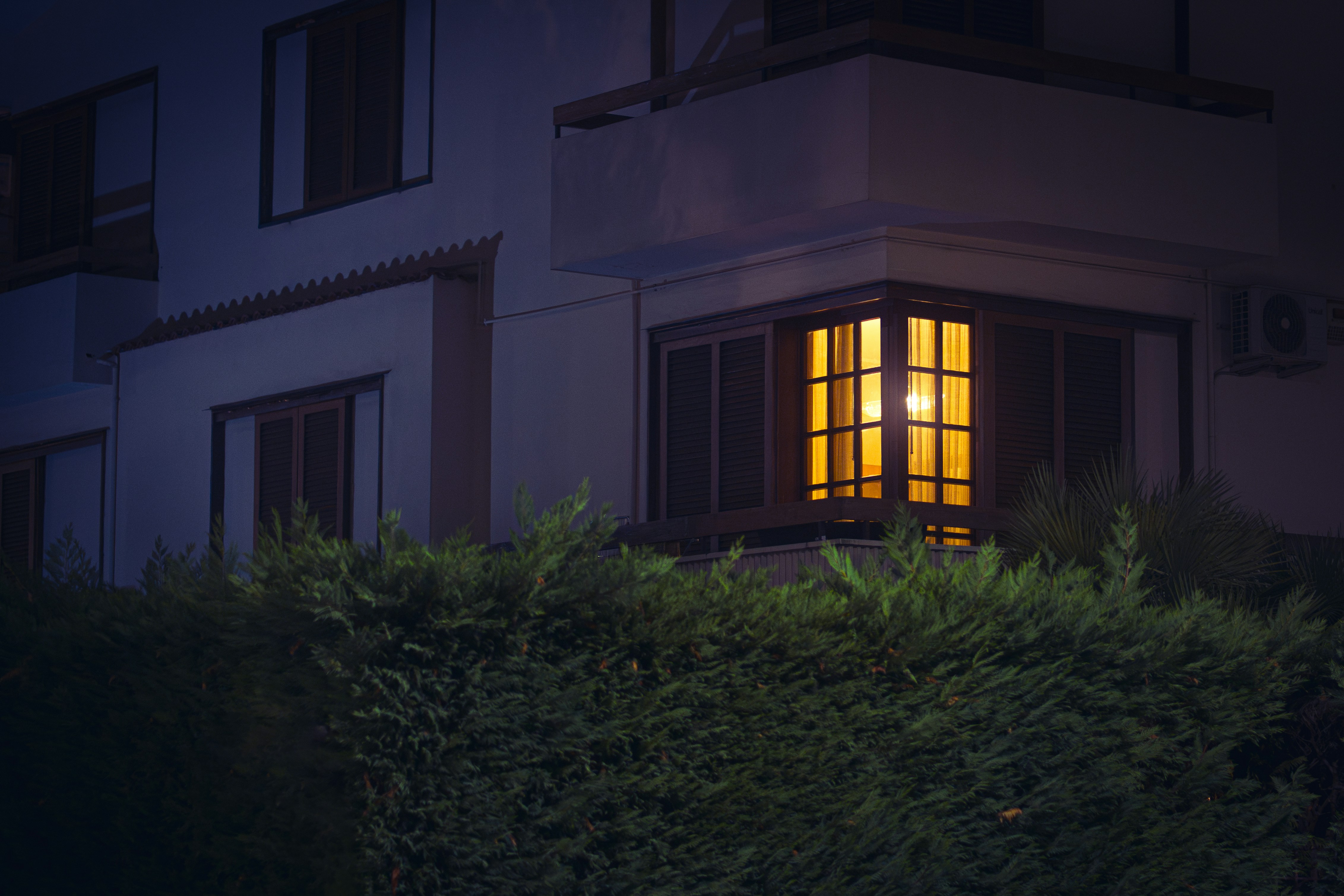 A building with a lit up window at night photo – Free Image on Unsplash
