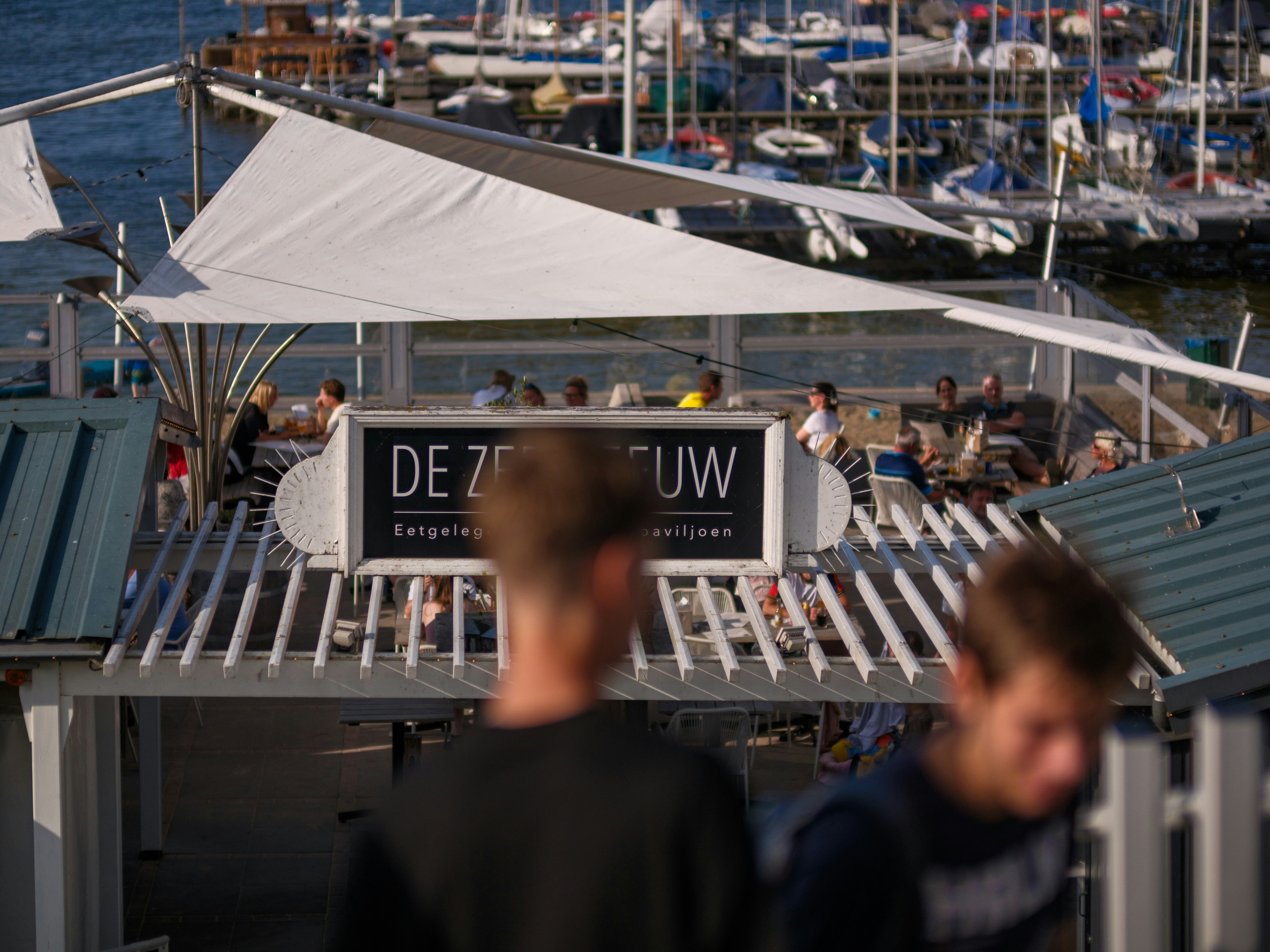 A group of people walking around a boat dock photo – Free Waterside ...