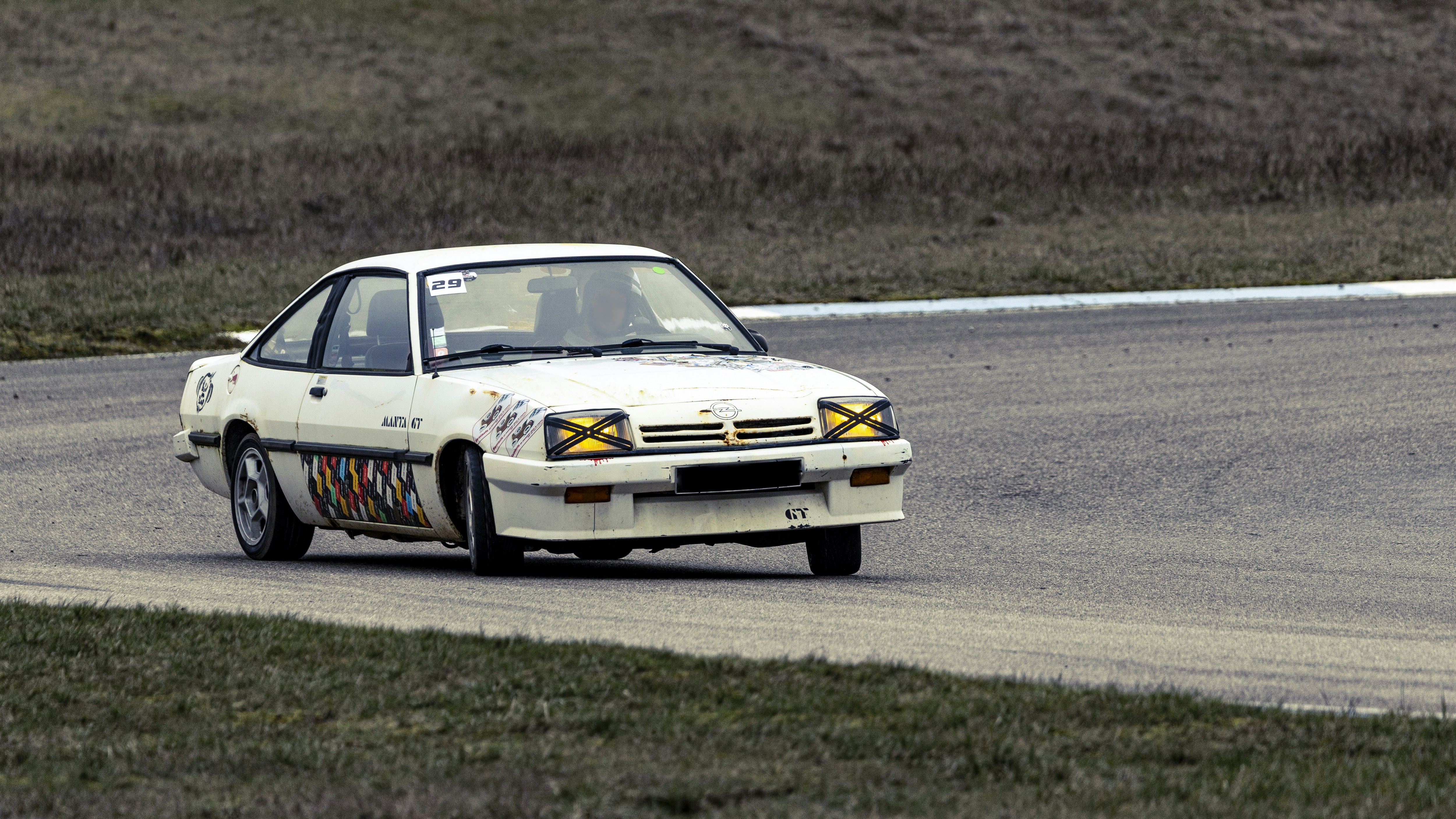 Curved Grit: A vintage race car carves a quiet turn on an empty track