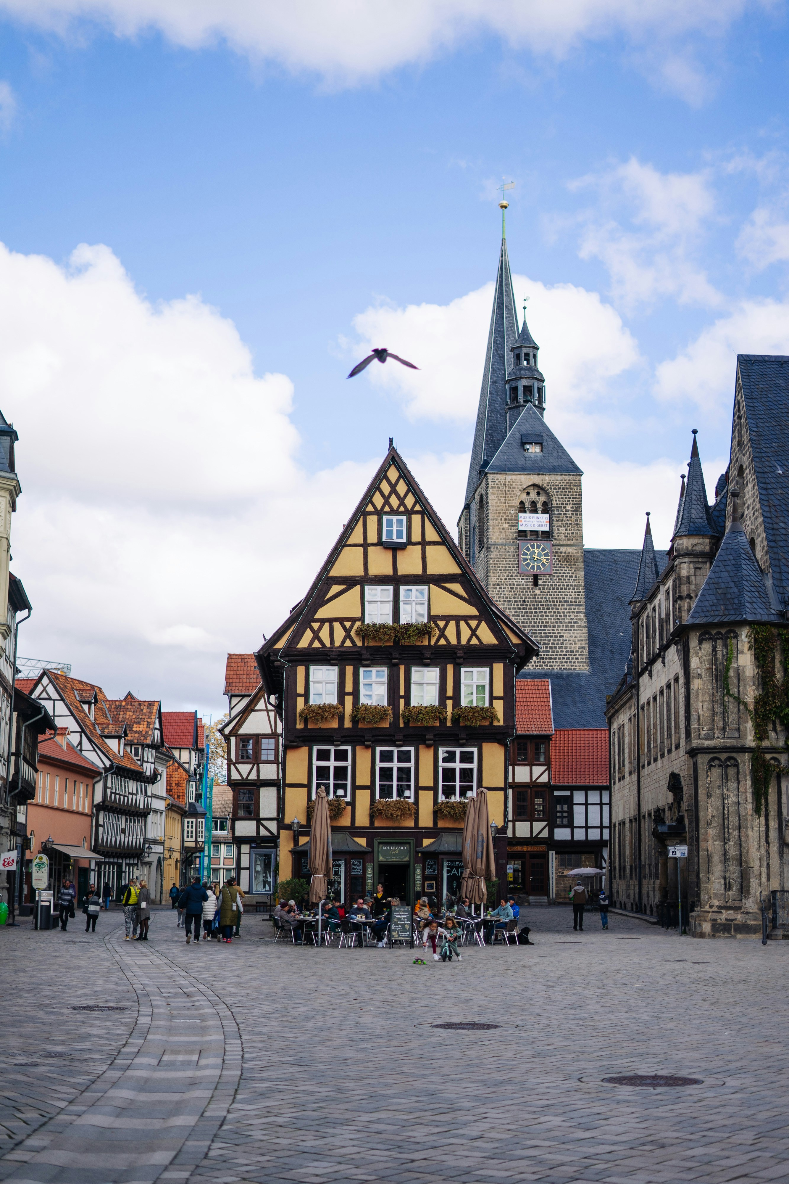 A cobblestone street lined with old buildings photo – Free Timber frame ...