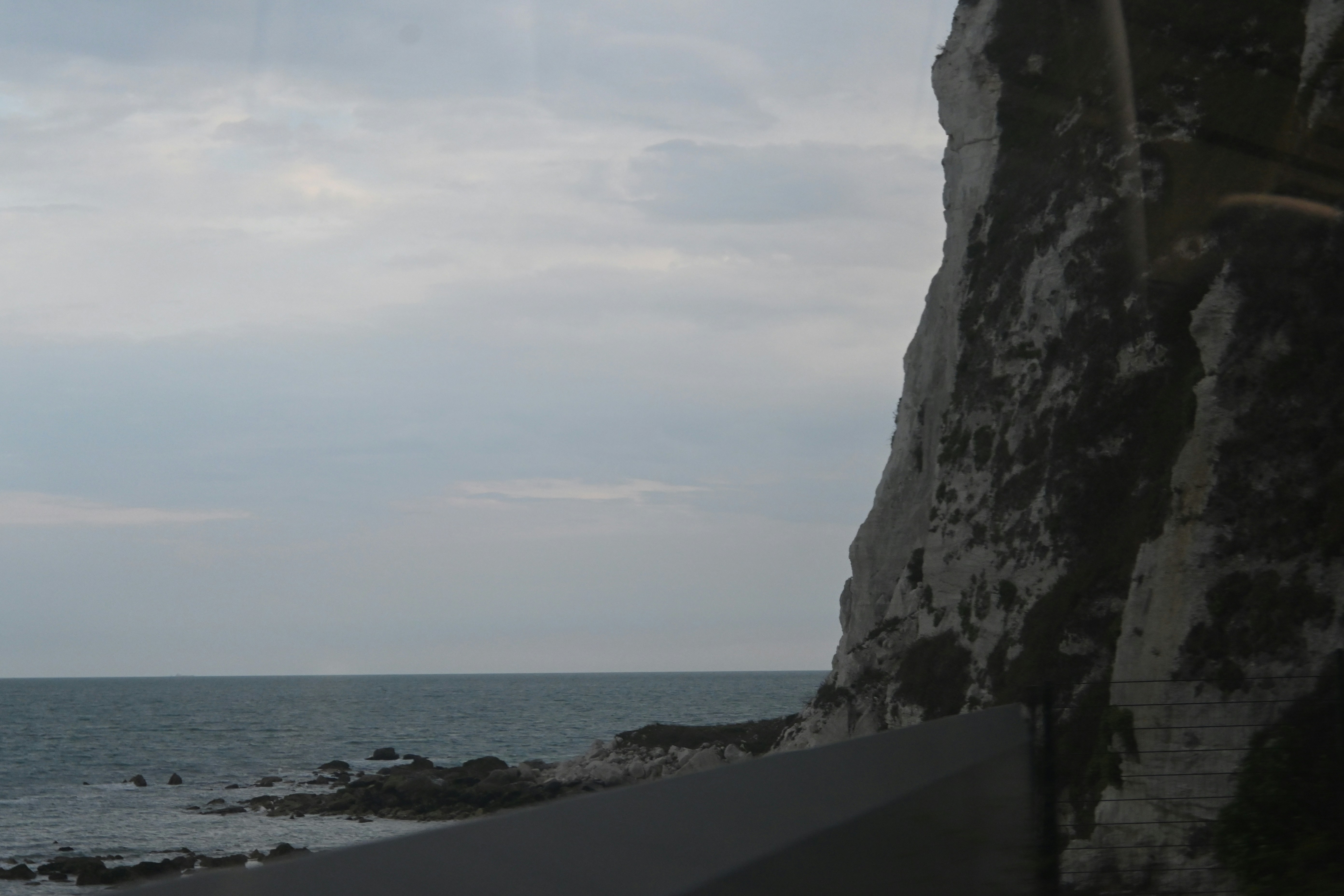 Cliffside Frame: A Narrow Railside View of Sea and Sky