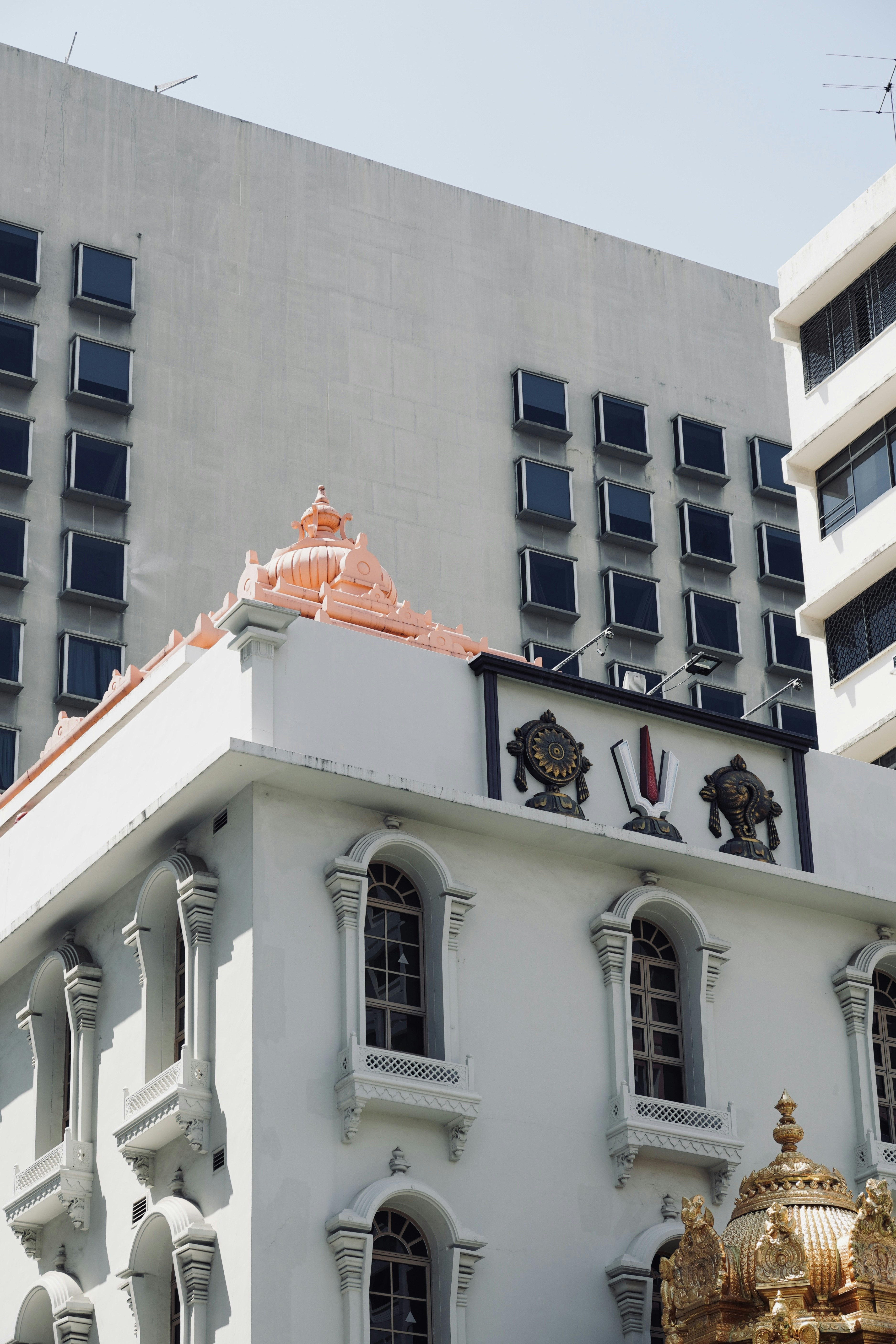 Ornate Temple Facade Framed by a Modern Concrete Horizon