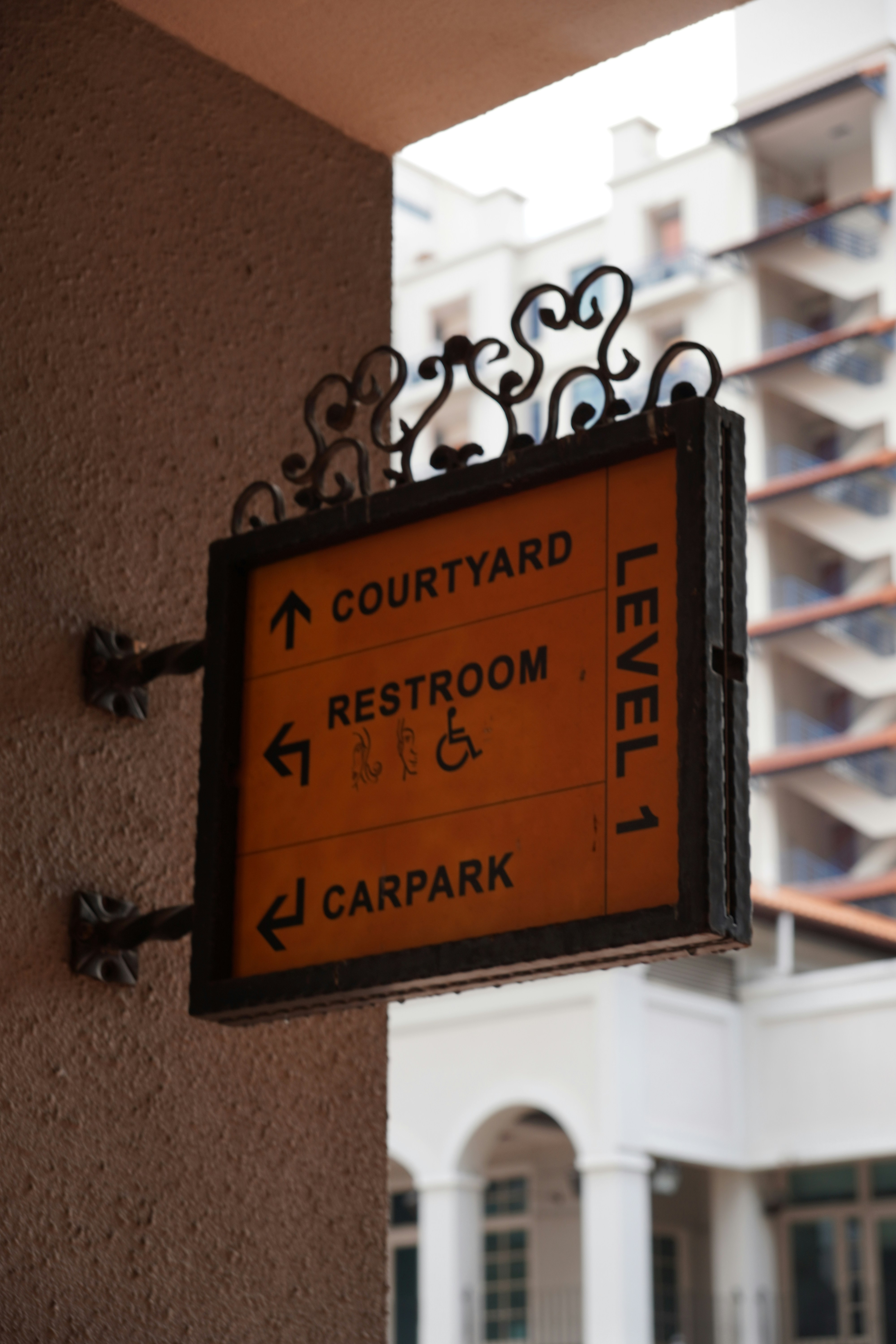Orange Signpost in an Archway: Directions at Level 1
