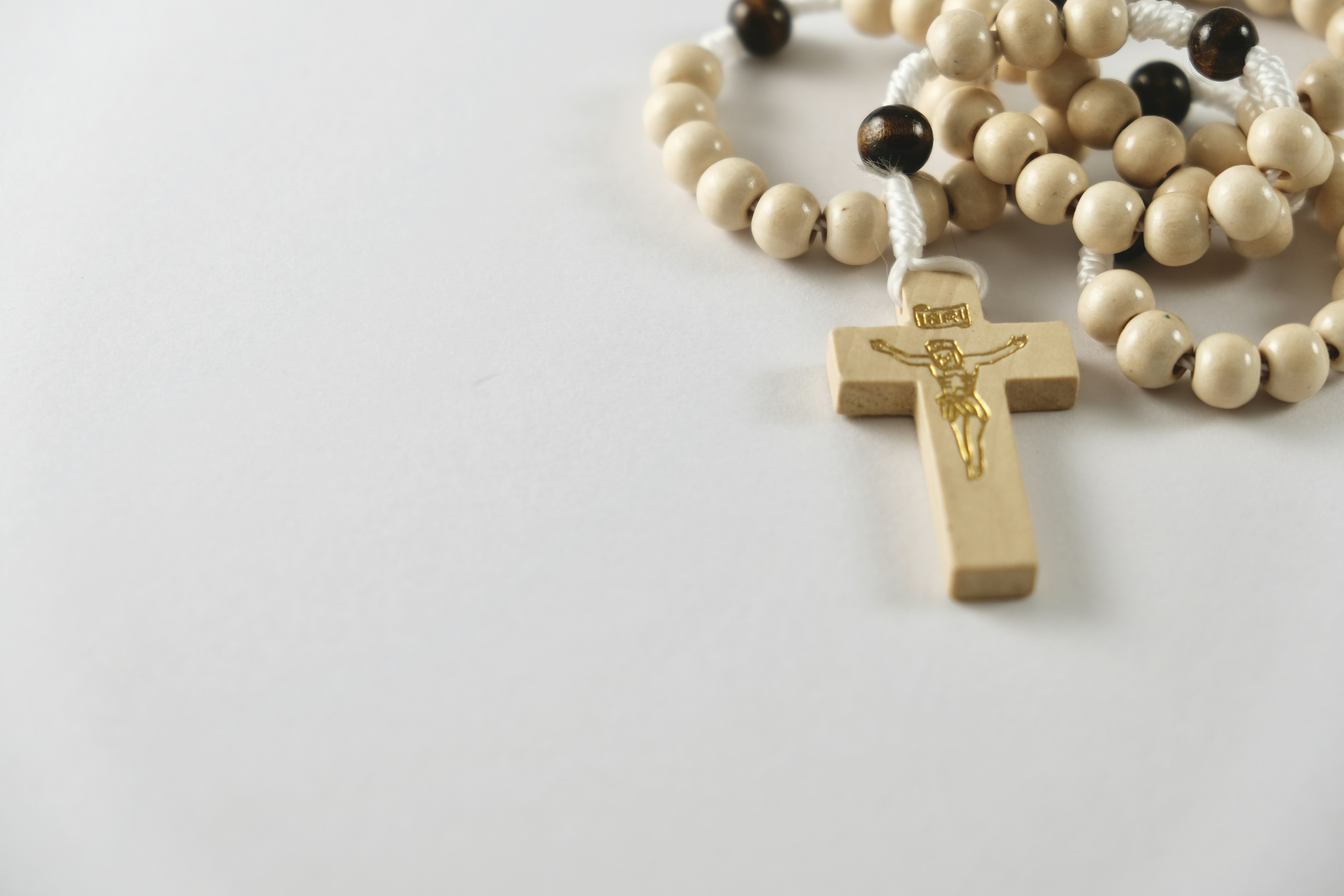 A rosary with a wooden cross on it