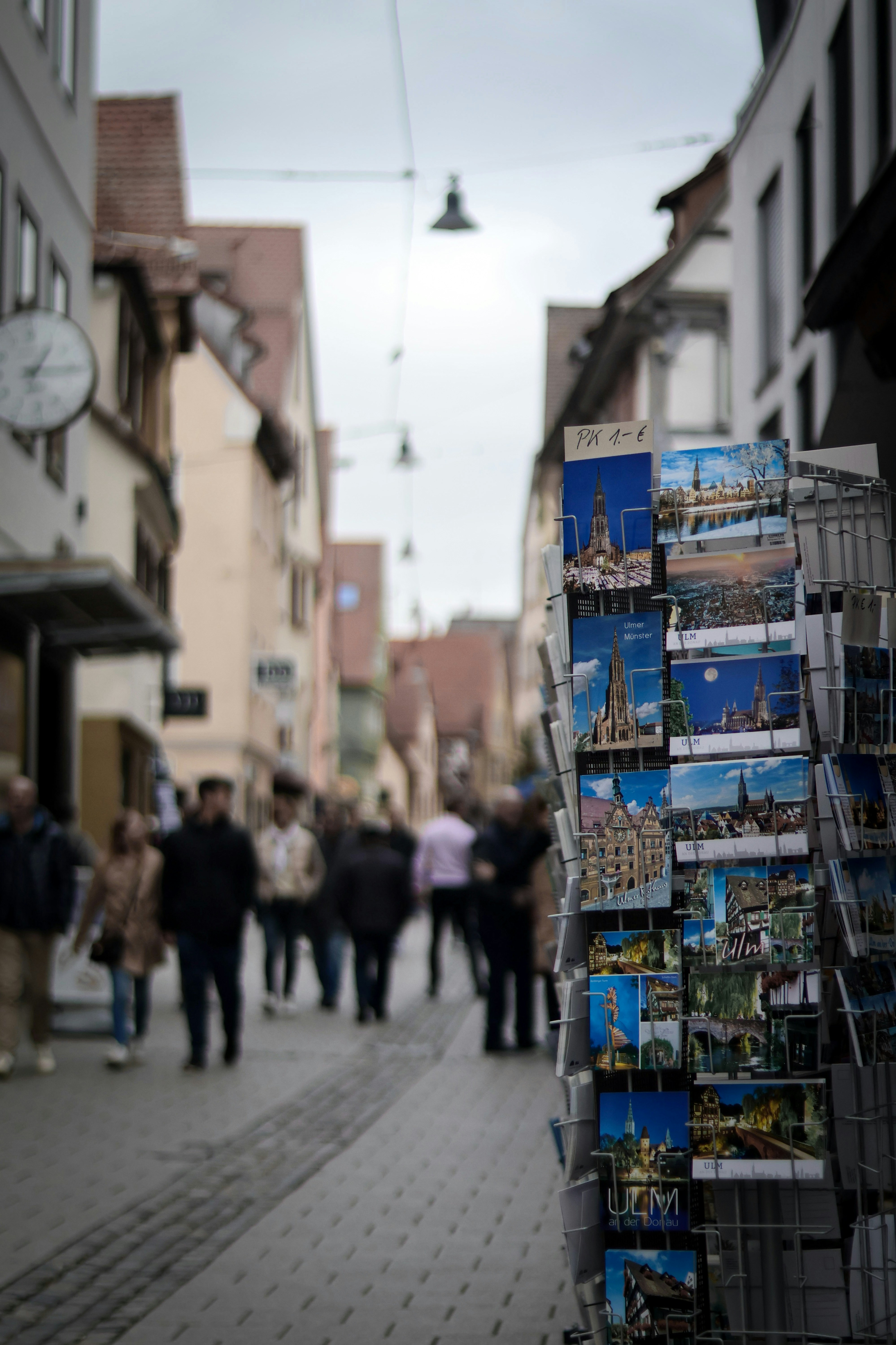 Postcard Stand Framing a Quiet European Street