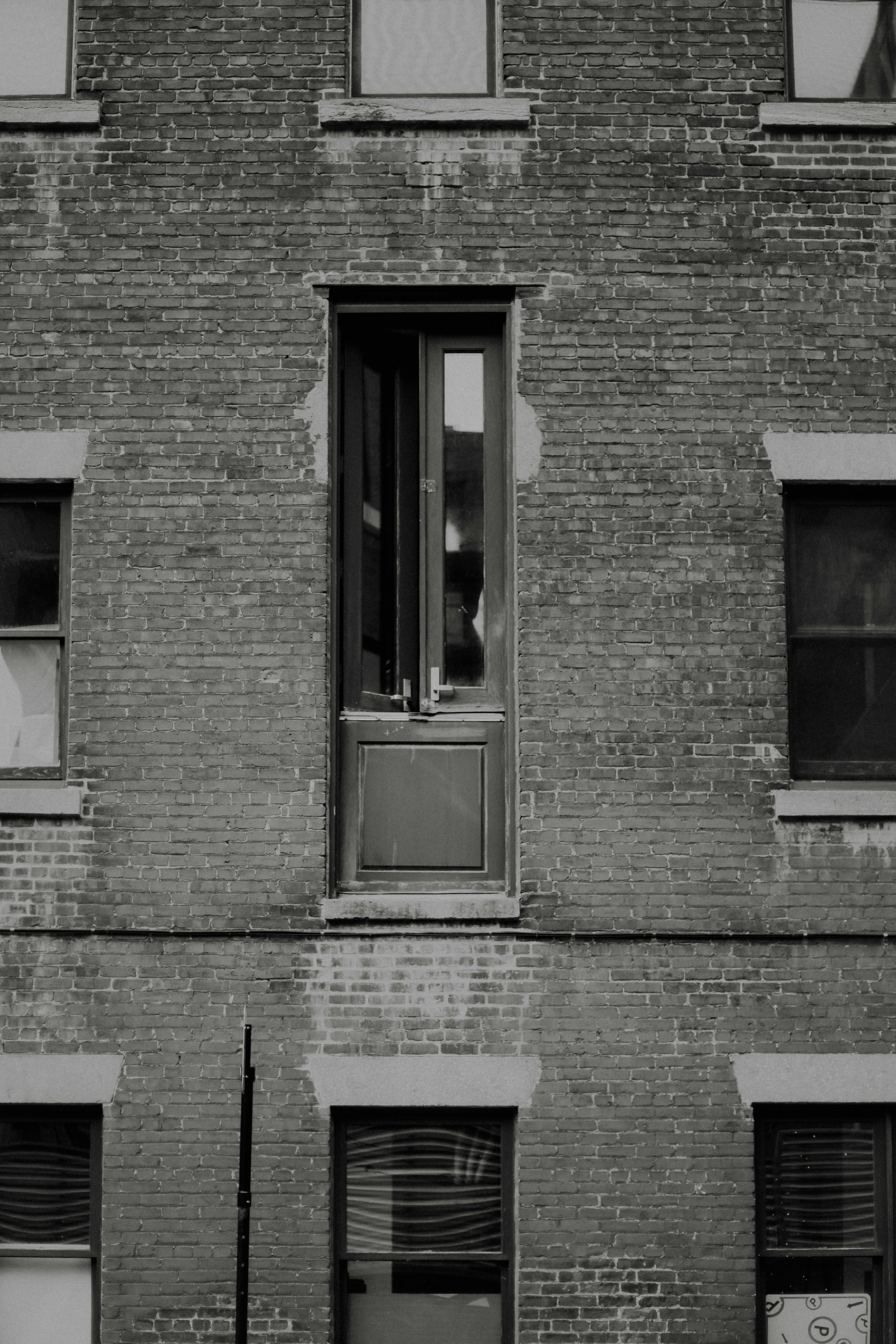 A black and white photo of a brick building photo – Free B&w Image on ...