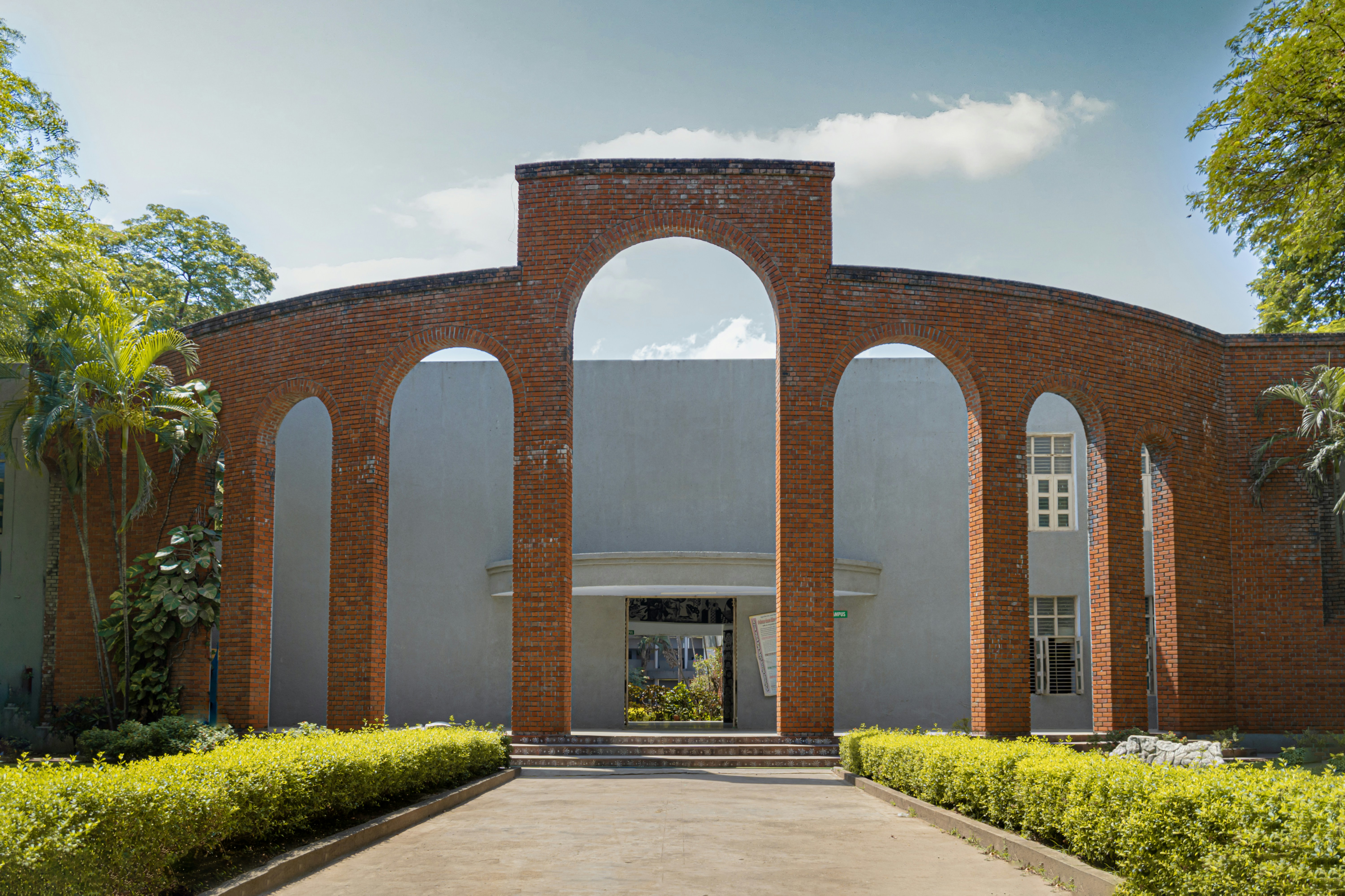 CVM building | A brick building with arches and a walkway leading to it