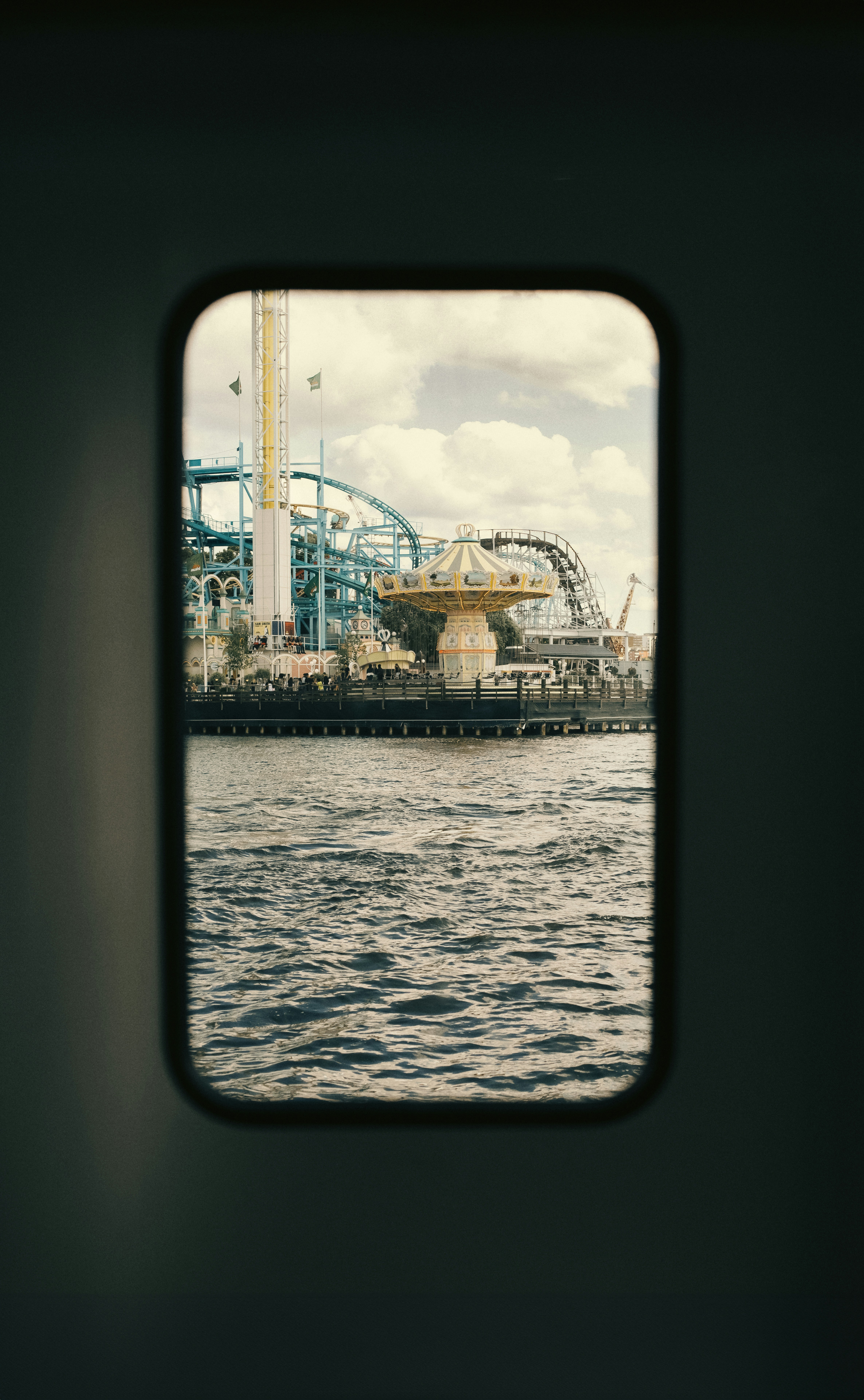 A view of a roller coaster through a window