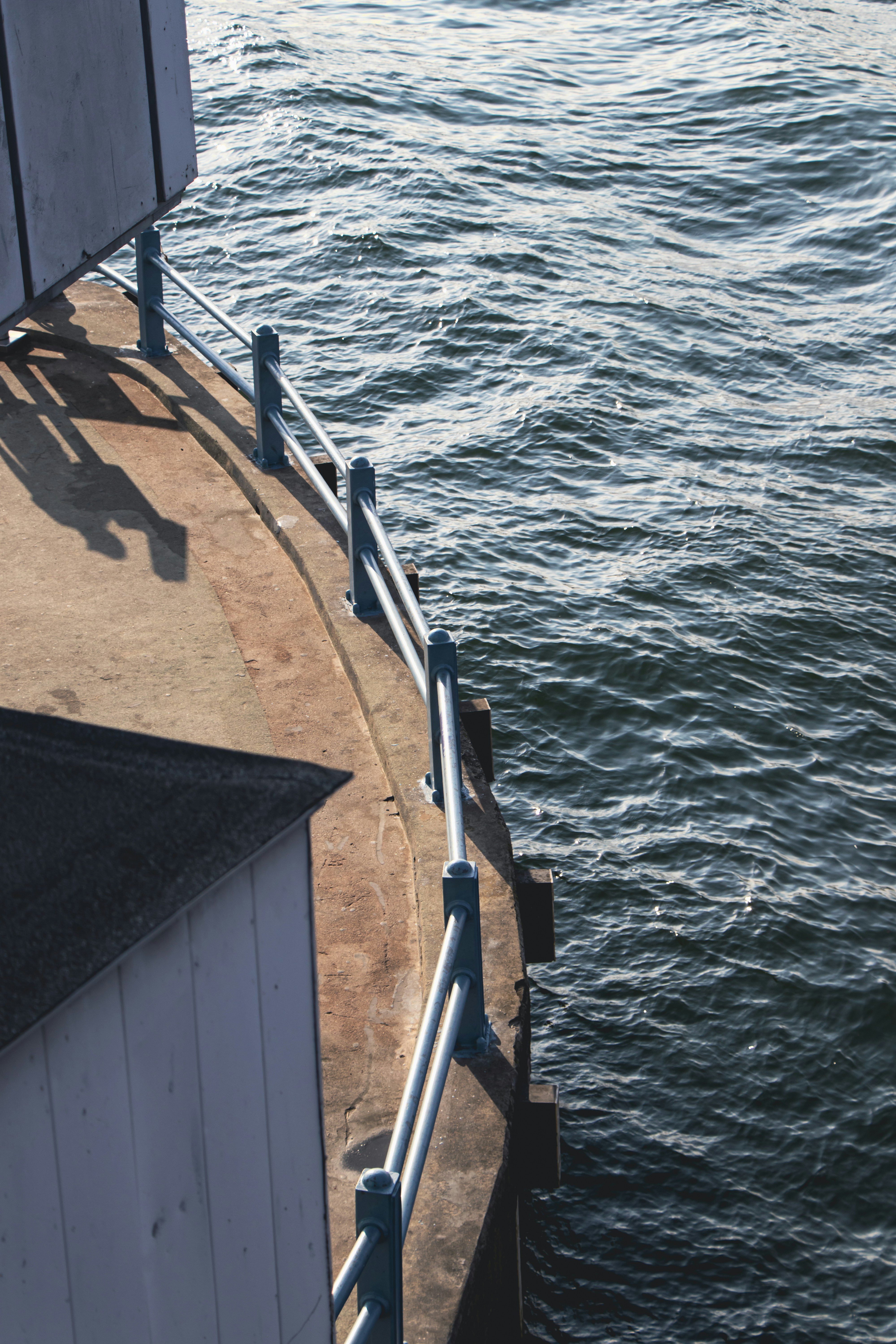 Curve of Steel and Sea: A Pier in Dappled Light