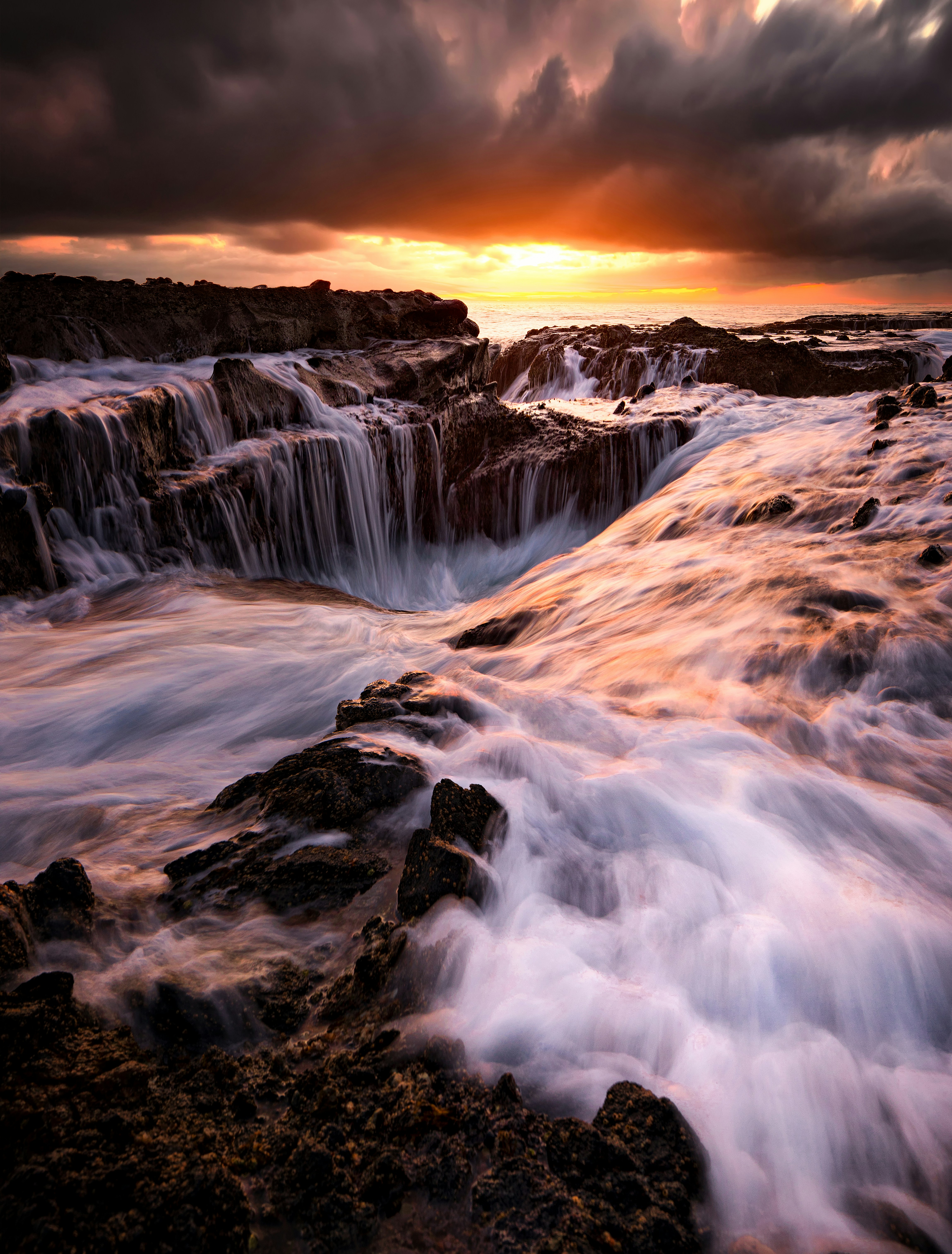A large body of water surrounded by rocks photo – Free Nature Image on ...
