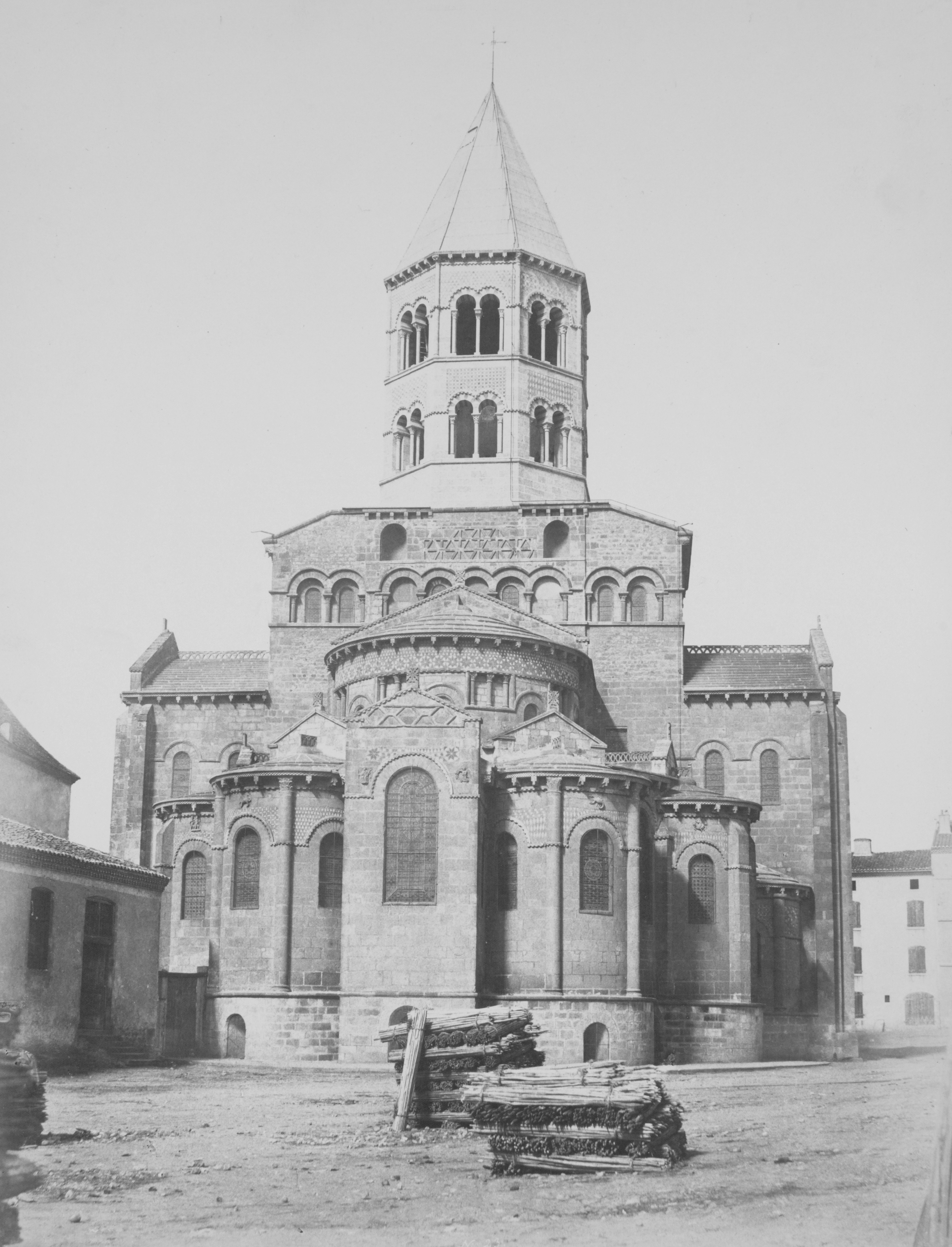 Monochrome Sentinel: Central Romanesque Tower Rising Over a Quiet Plaza