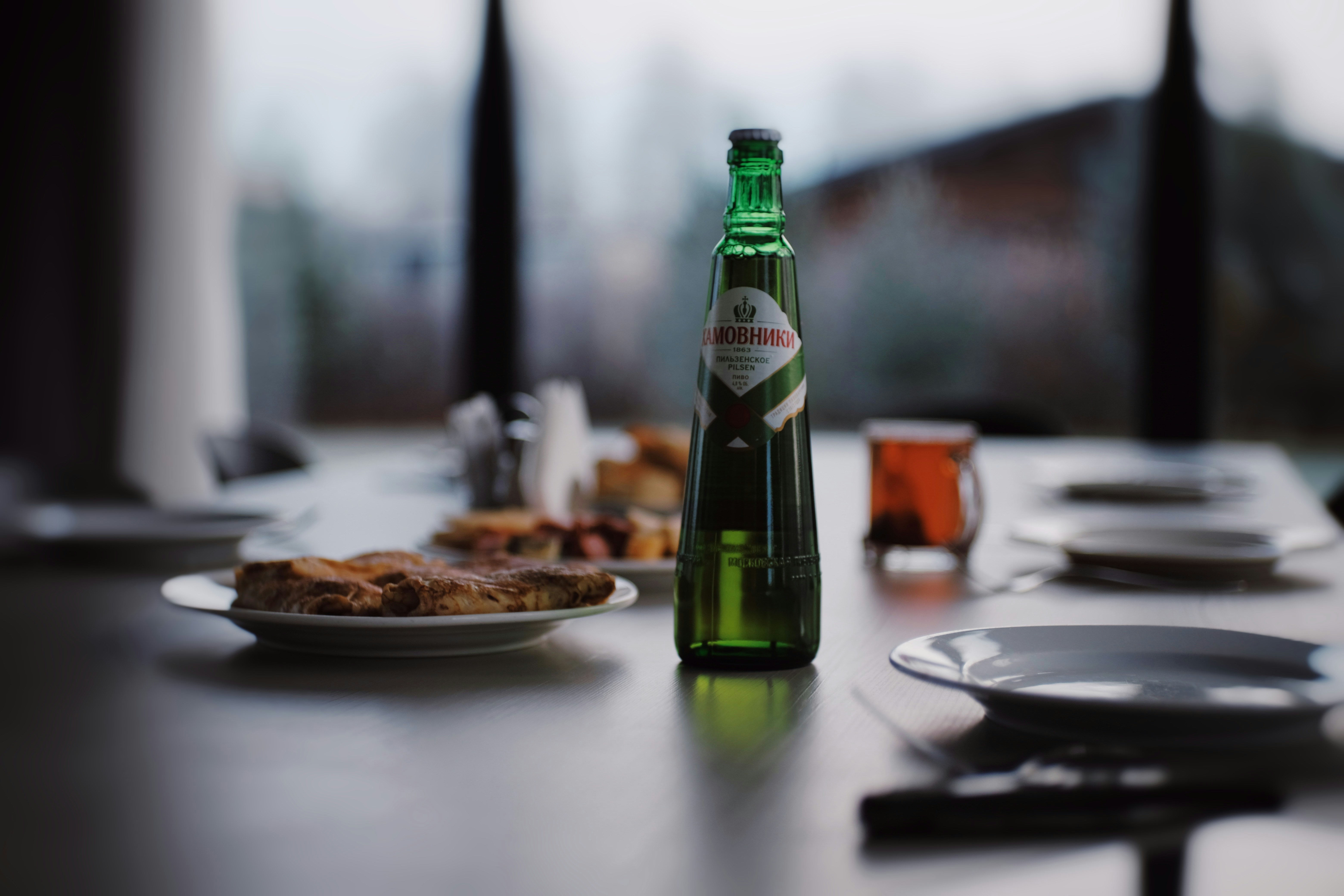 A bottle of beer sitting on top of a table photo – Free Food Image on ...