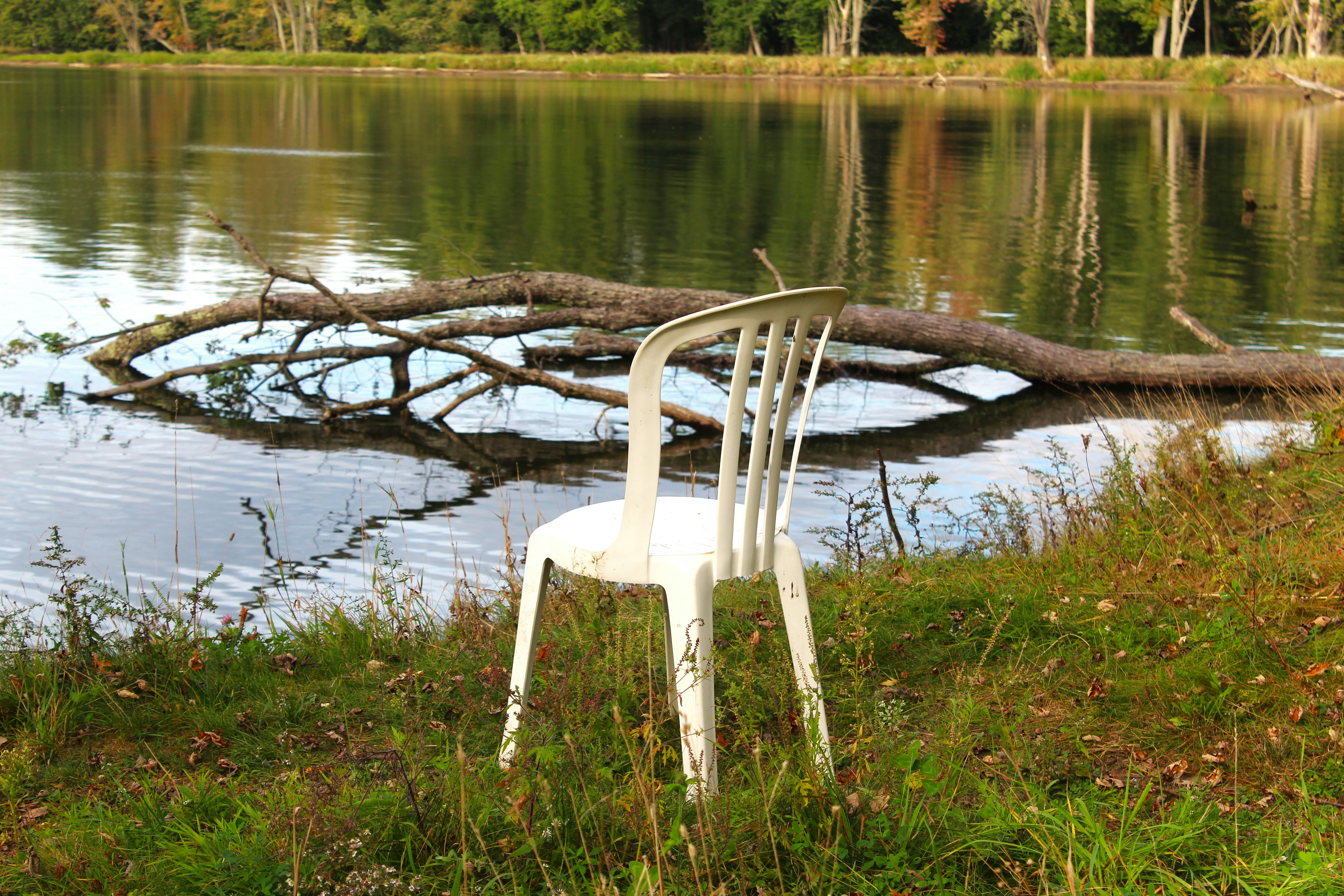 The Last Seat by the Lake: White Chair Framed by Reflections