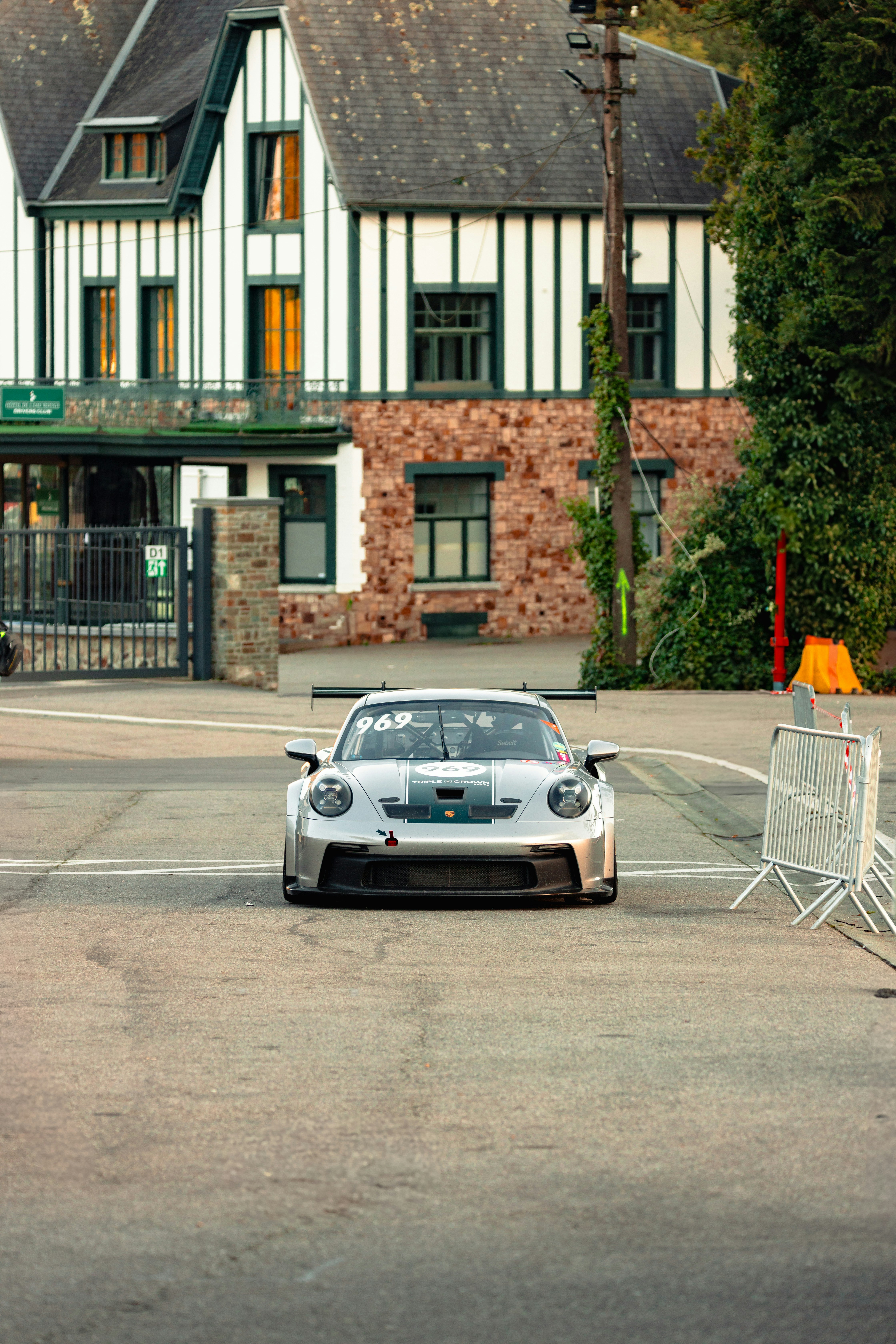 Race-Ready on Tudor Street: White Porsche 911 GT3 at a Barrier Crossing