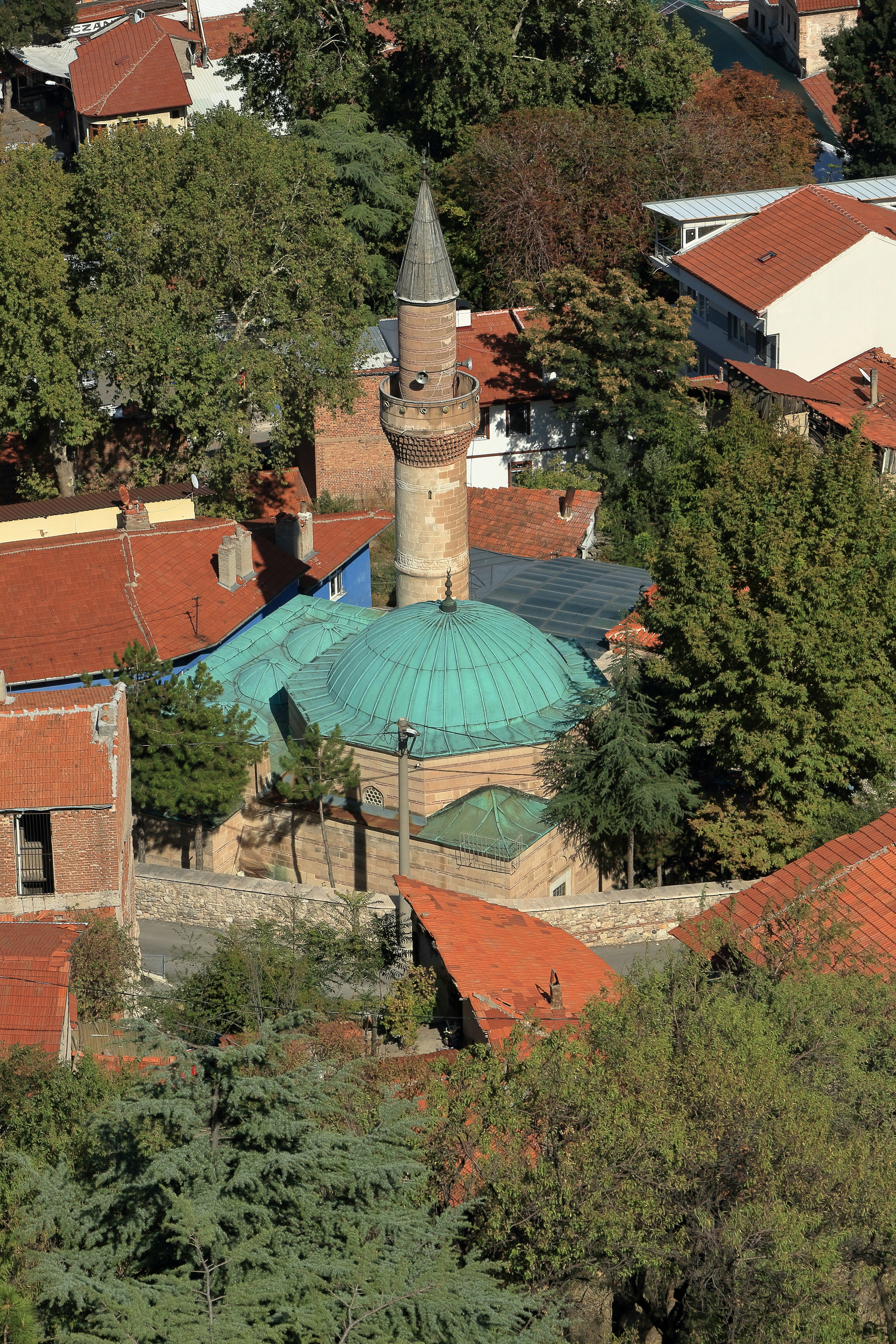 Turquoise Dome Amid an Autumn Canopy: A Mosque's Aerial Portrait