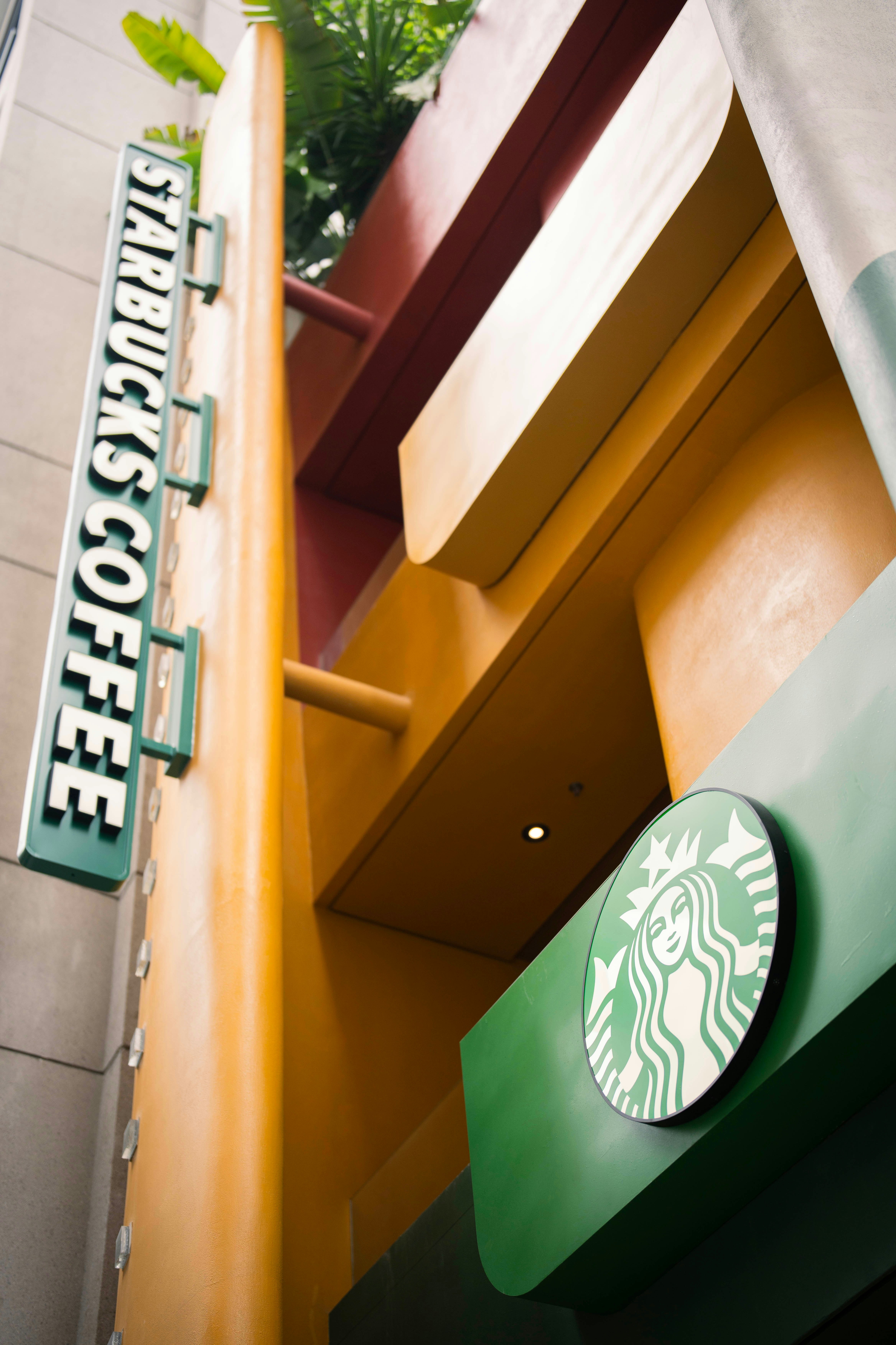 starbucks | A starbucks sign on the side of a building