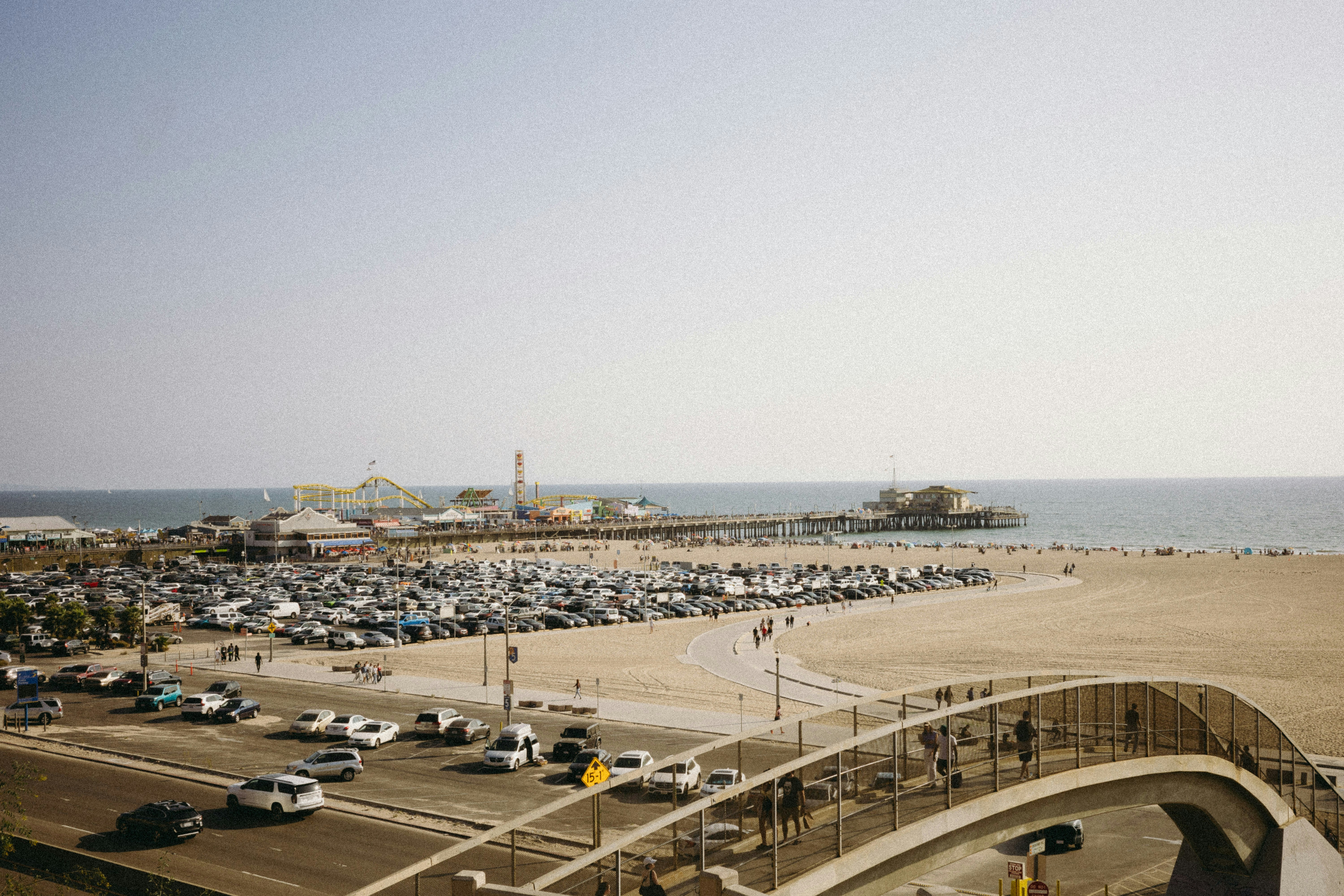 Curved Promenade, Busy Beachfront, and Pier by the Sea