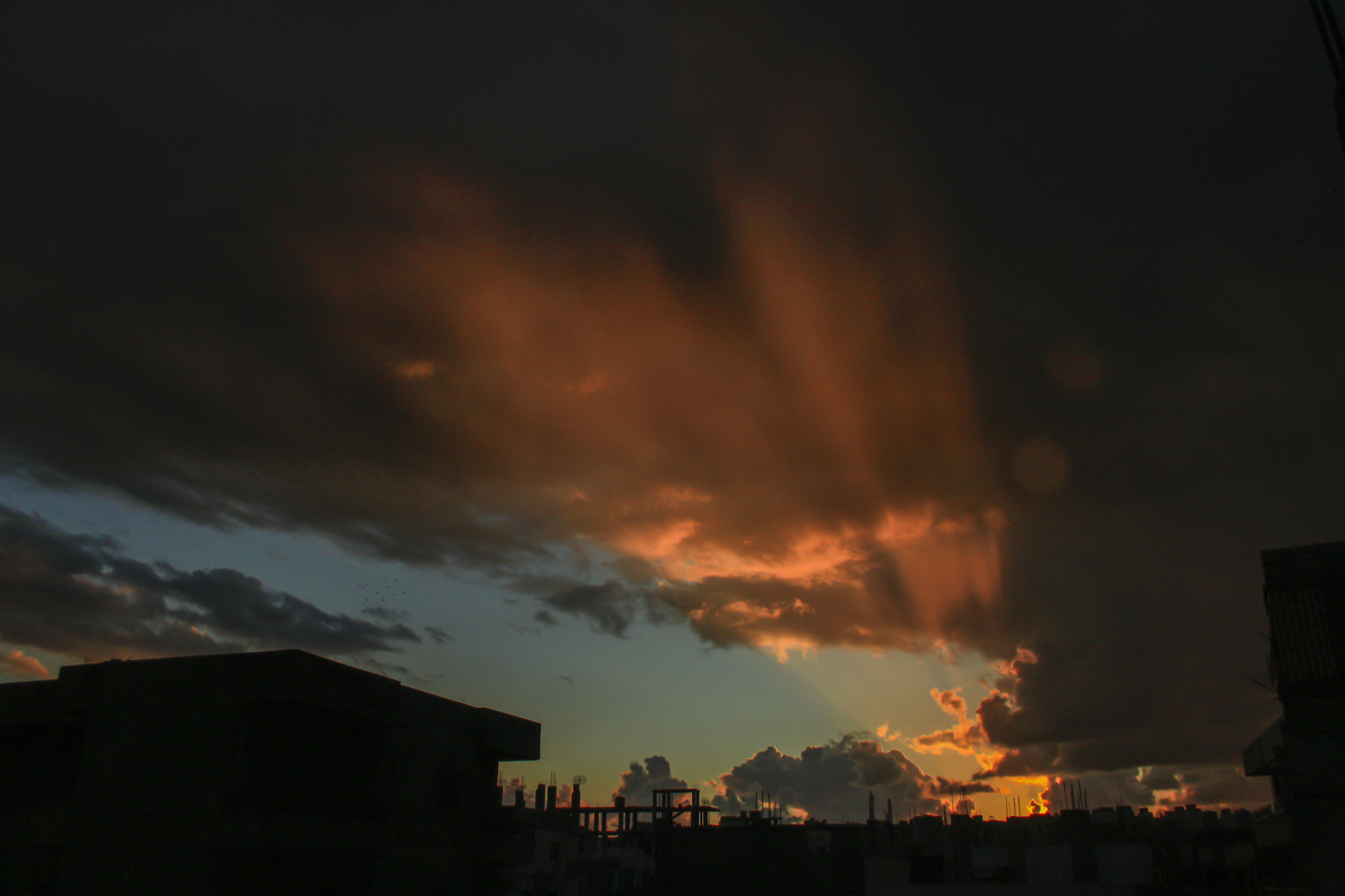 Ember Clouds Over a Silent Skyline at Dusk