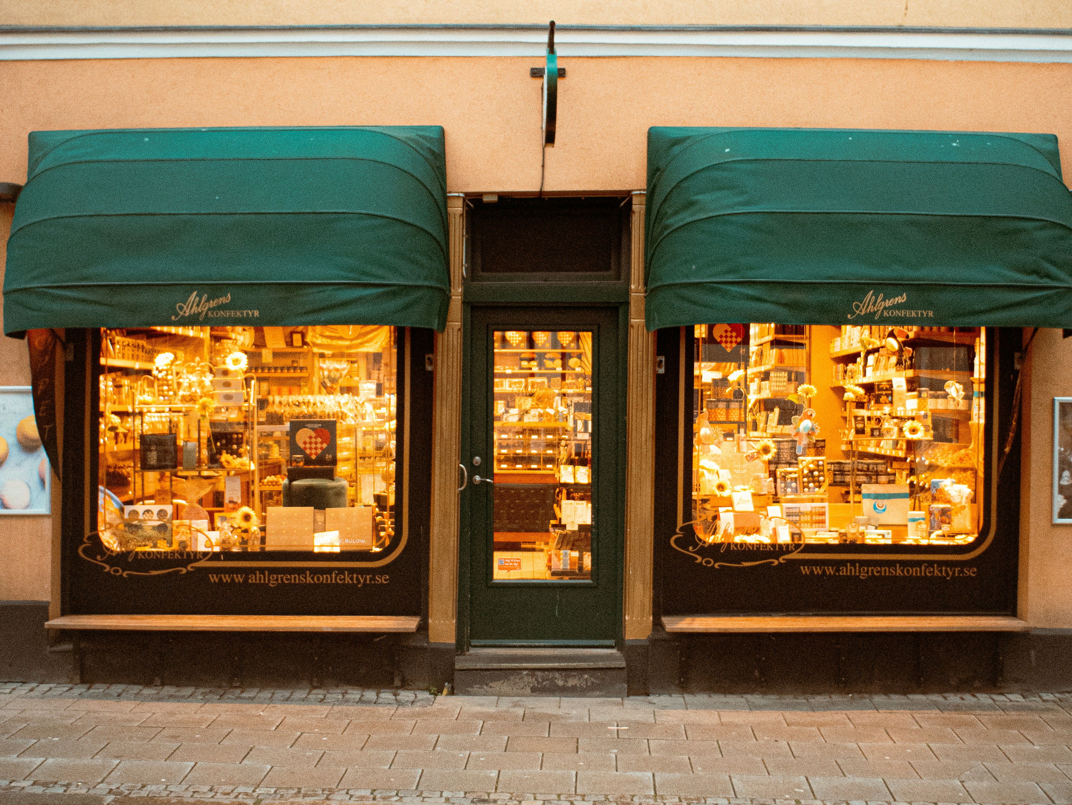 Emerald Awnings Framing a Softly Lit Central Shopfront