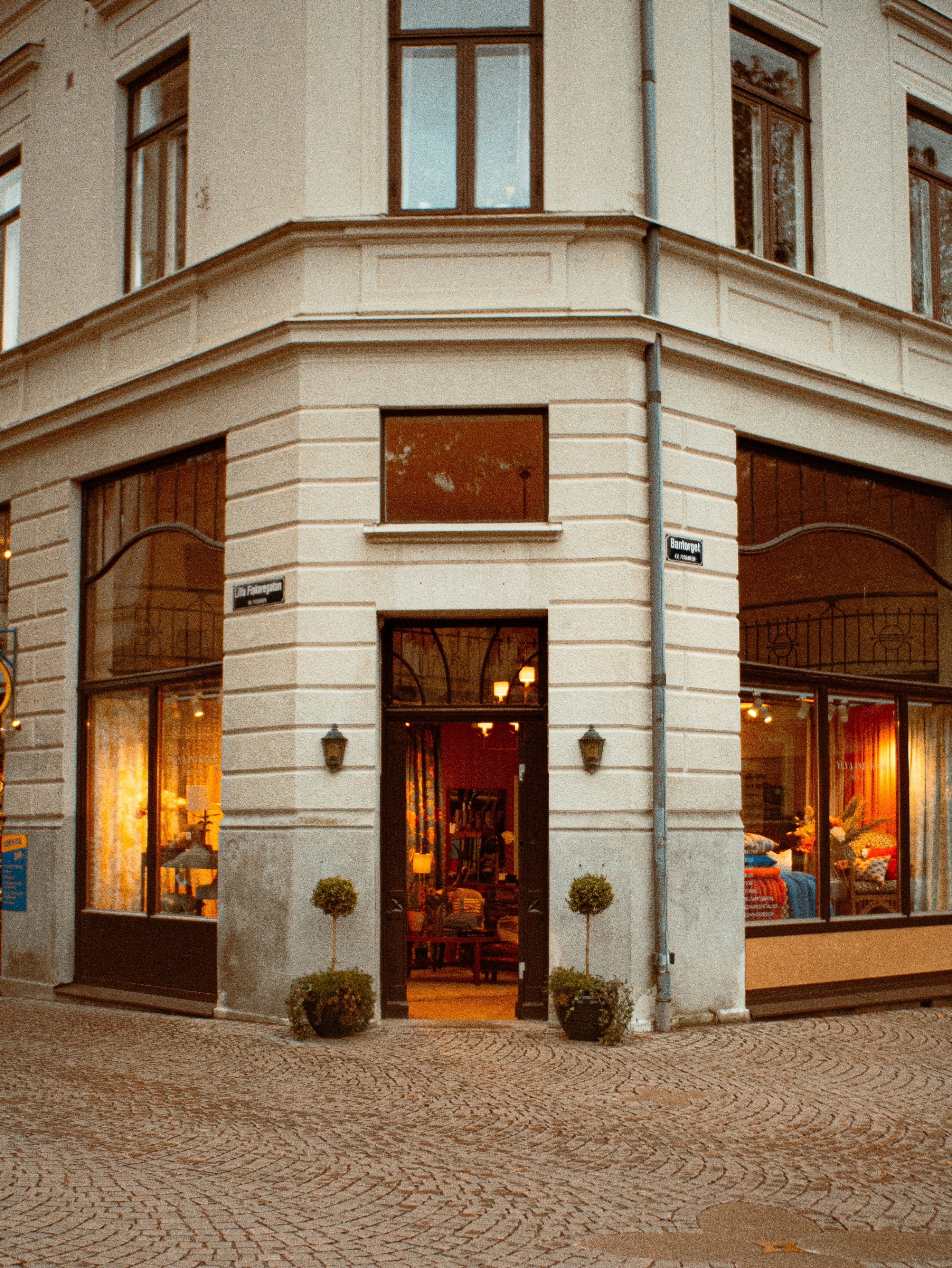 A large white building with a store front photo – Free City Image on ...