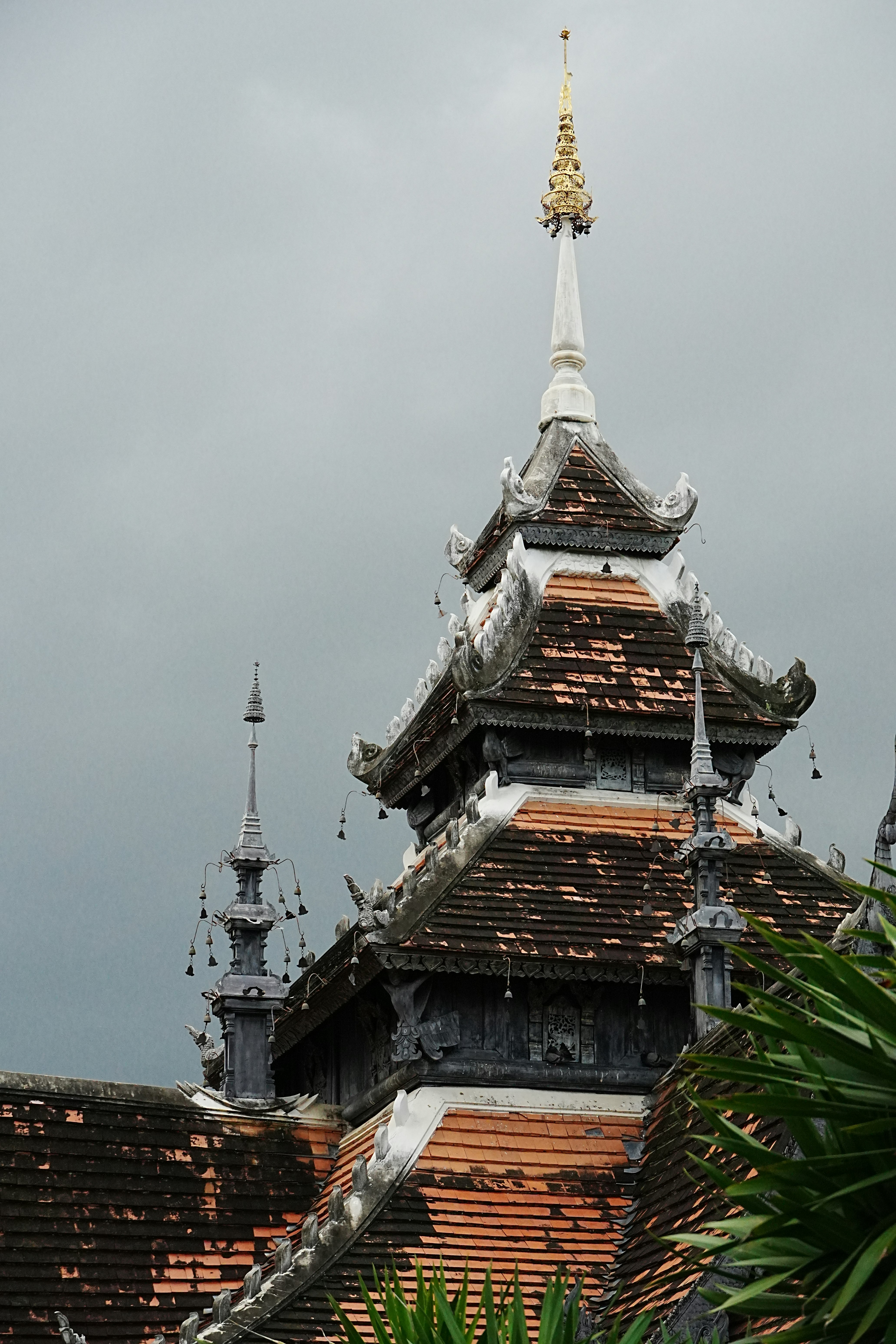 Crowned Tiers under a Stormbound Sky: A Weathered Southeast Asian Pagoda