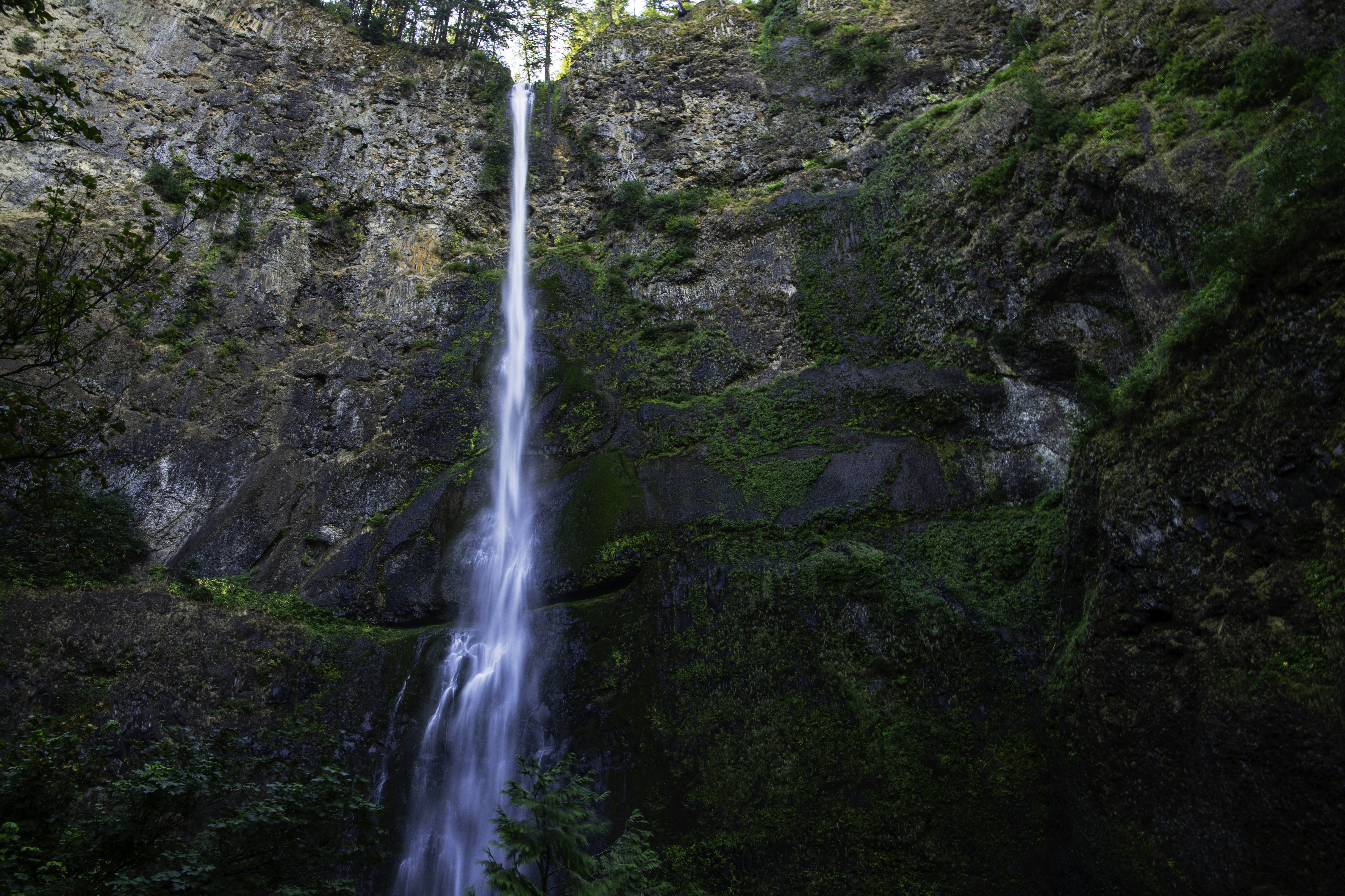 A tall waterfall with a waterfall in the middle of it photo – Free ...