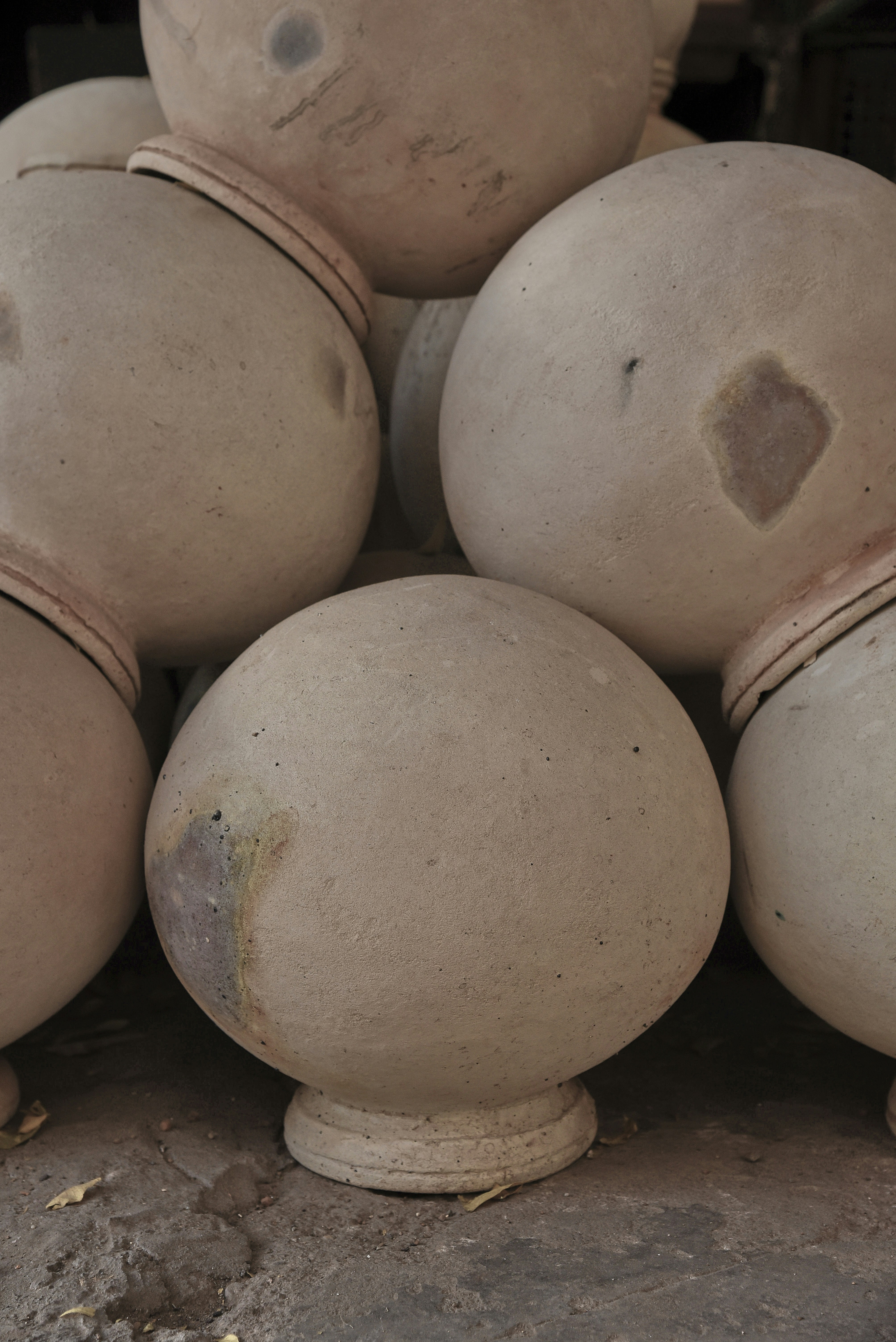 Whispers of Clay: A Stack of Dusty Terracotta Orbs