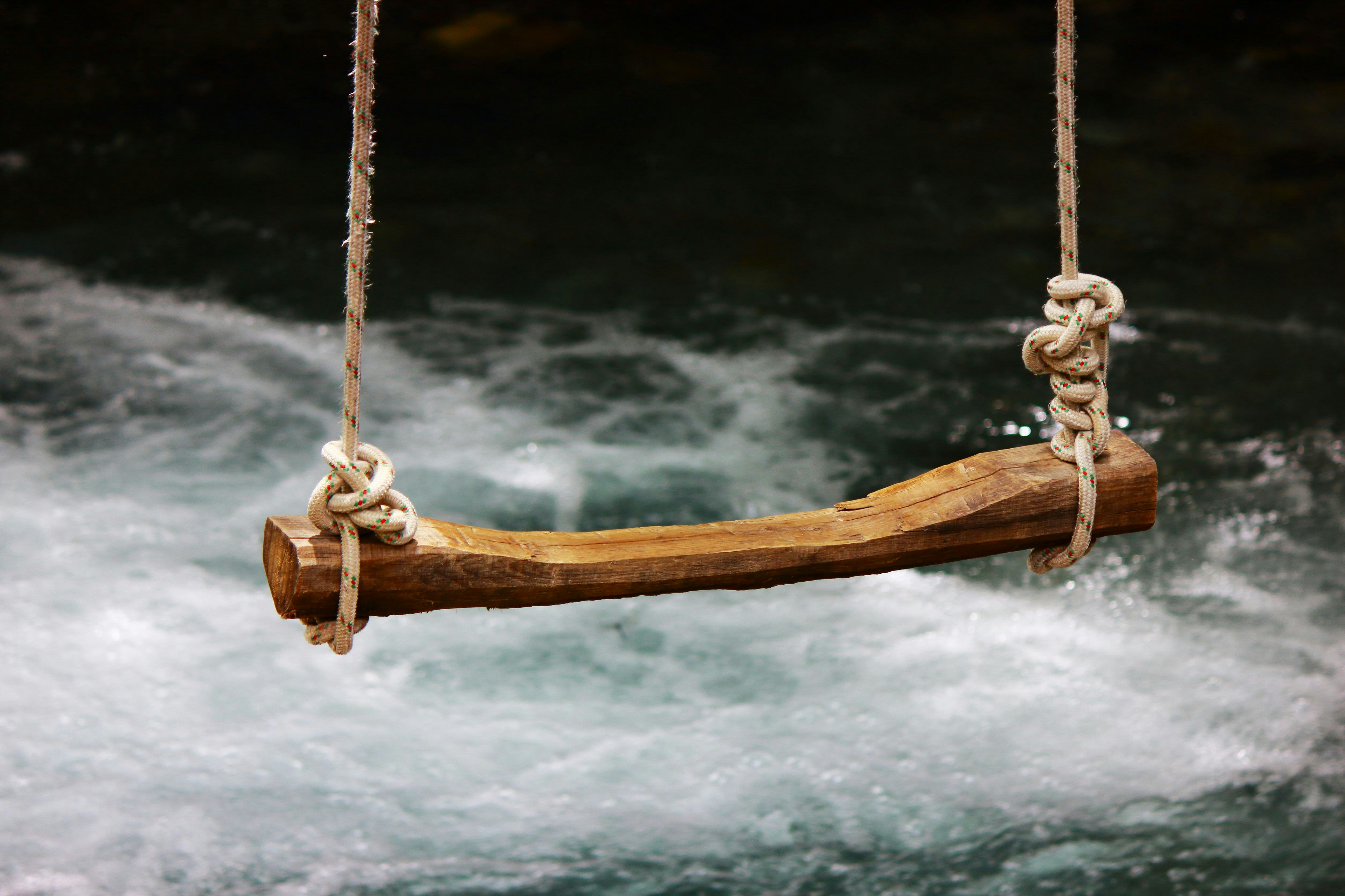Timber Tranquility: The Swing Above the Rapids