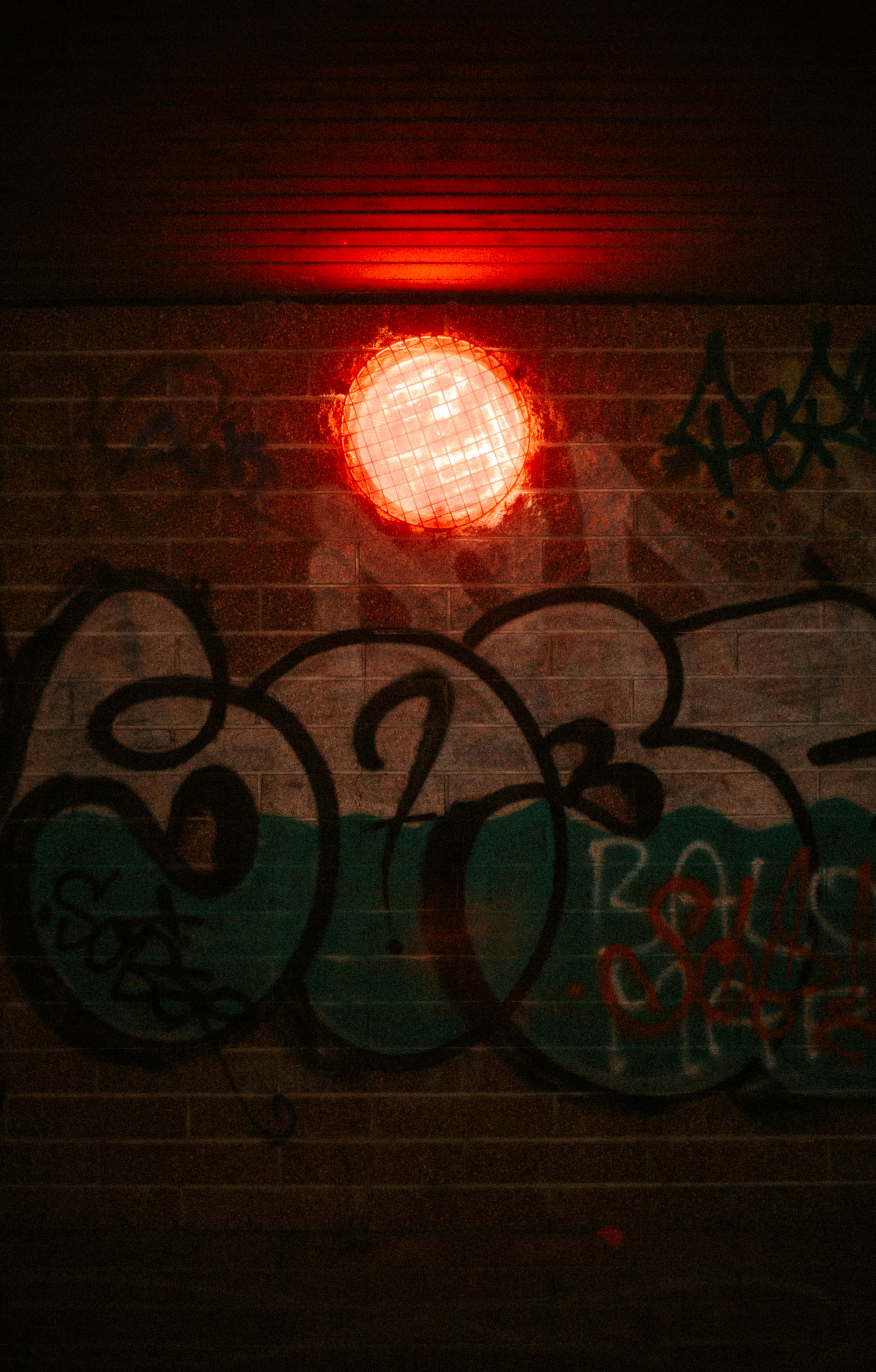 Red Halo Over Graffiti Brick Wall