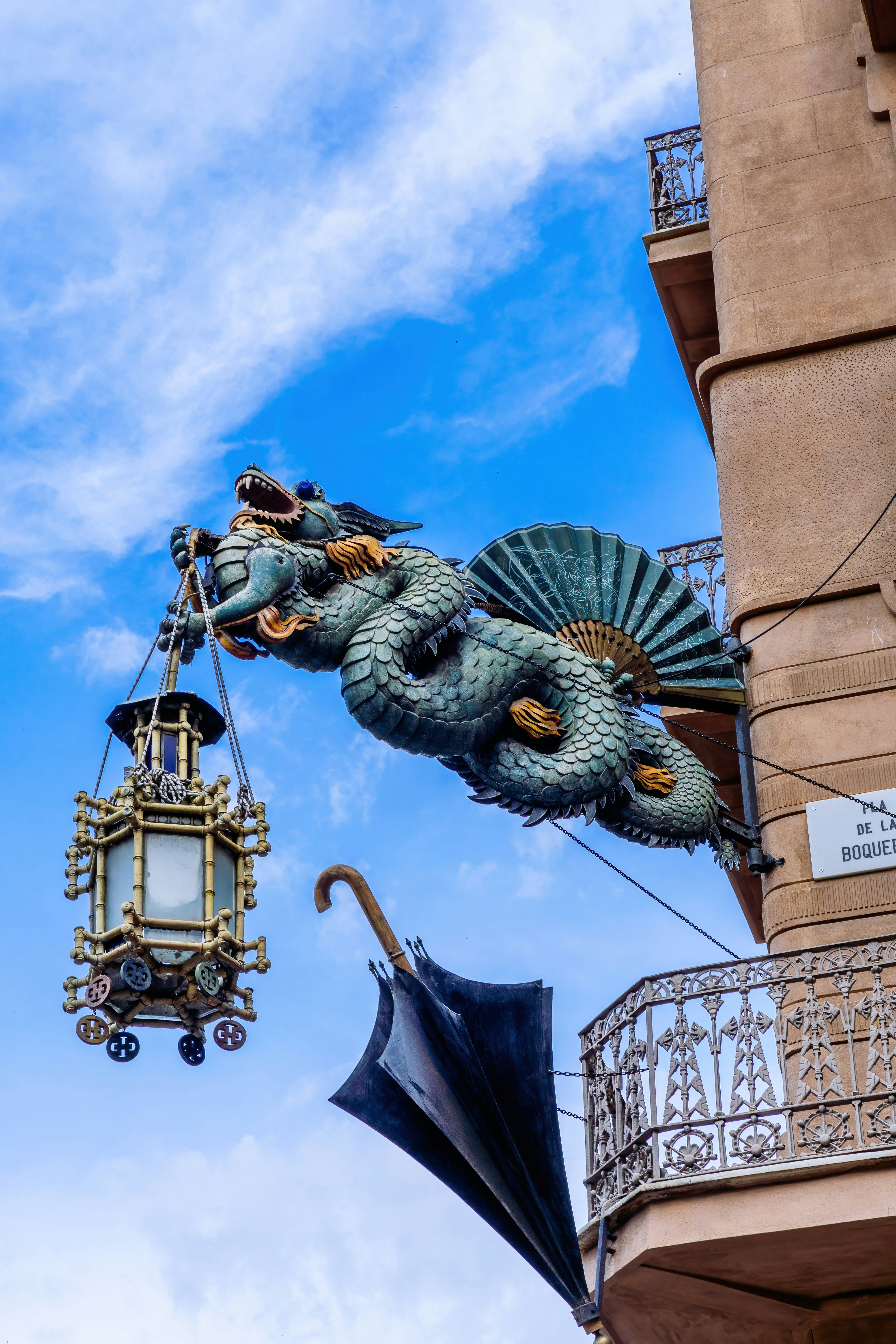 A building with a dragon sculpture hanging from it's side