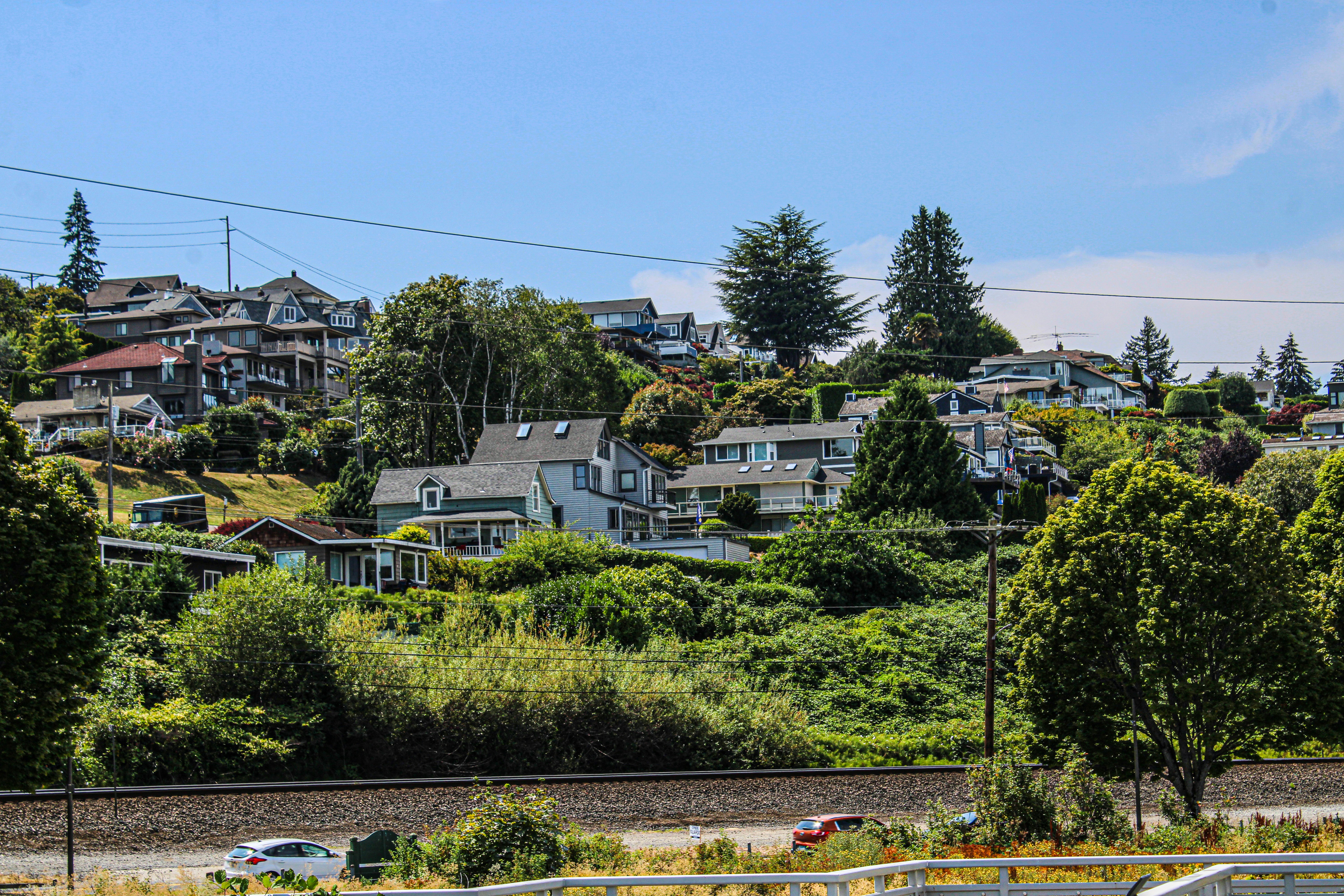 Suburban hillside mosaic under a bright, blue sky