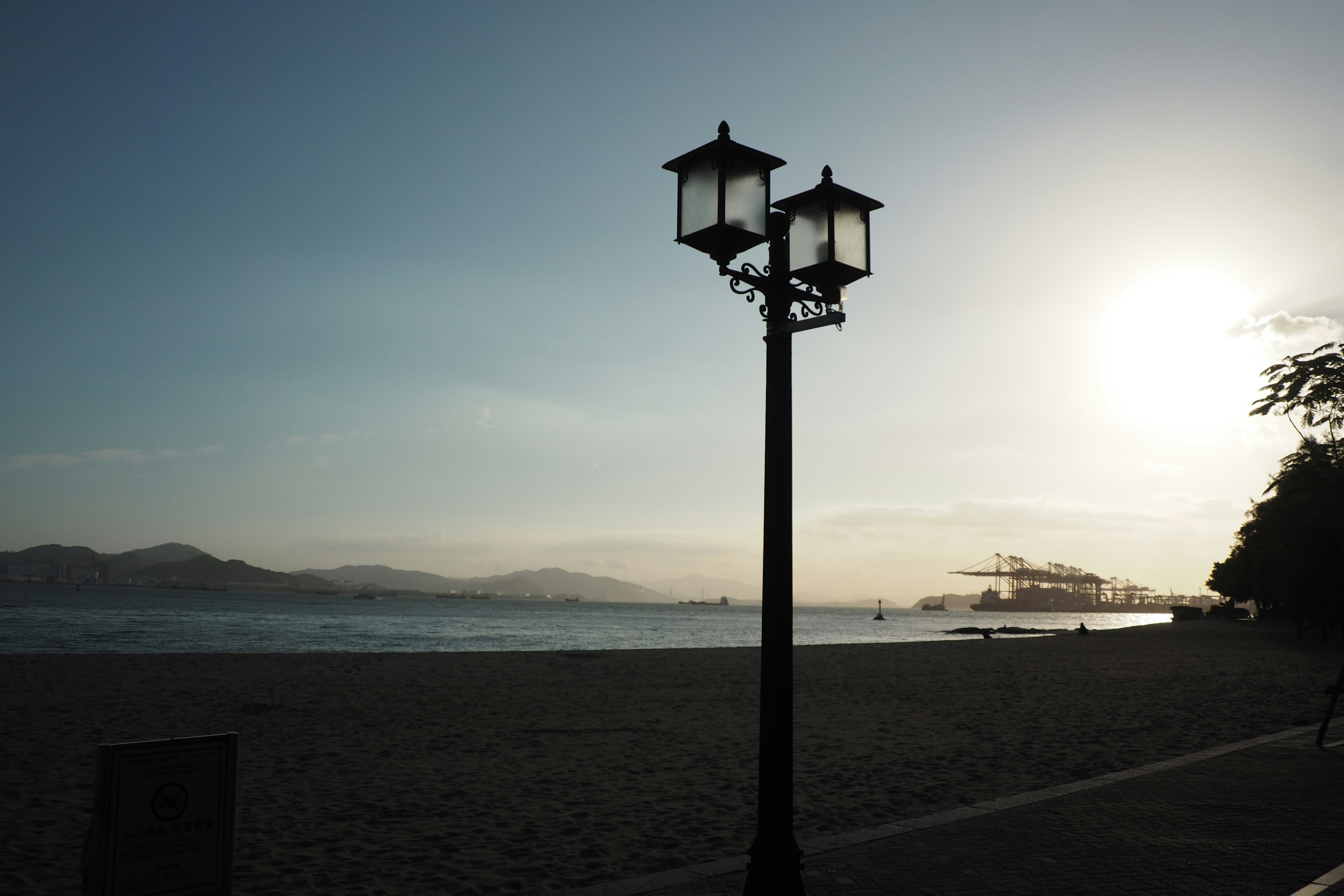 Lanterns on a Quiet Shore at Sunset
