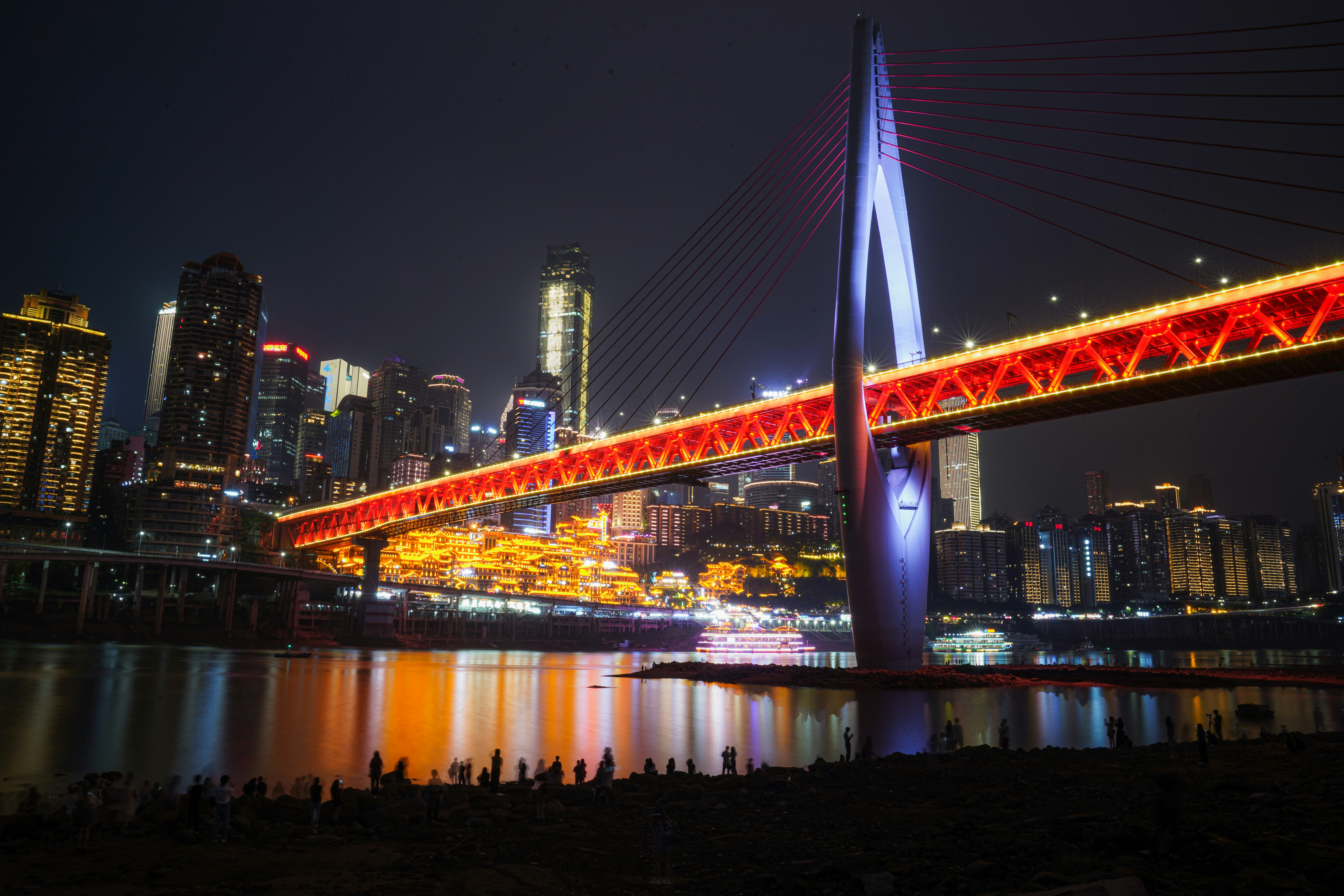 A large red bridge spanning over a large body of water photo – Free ...