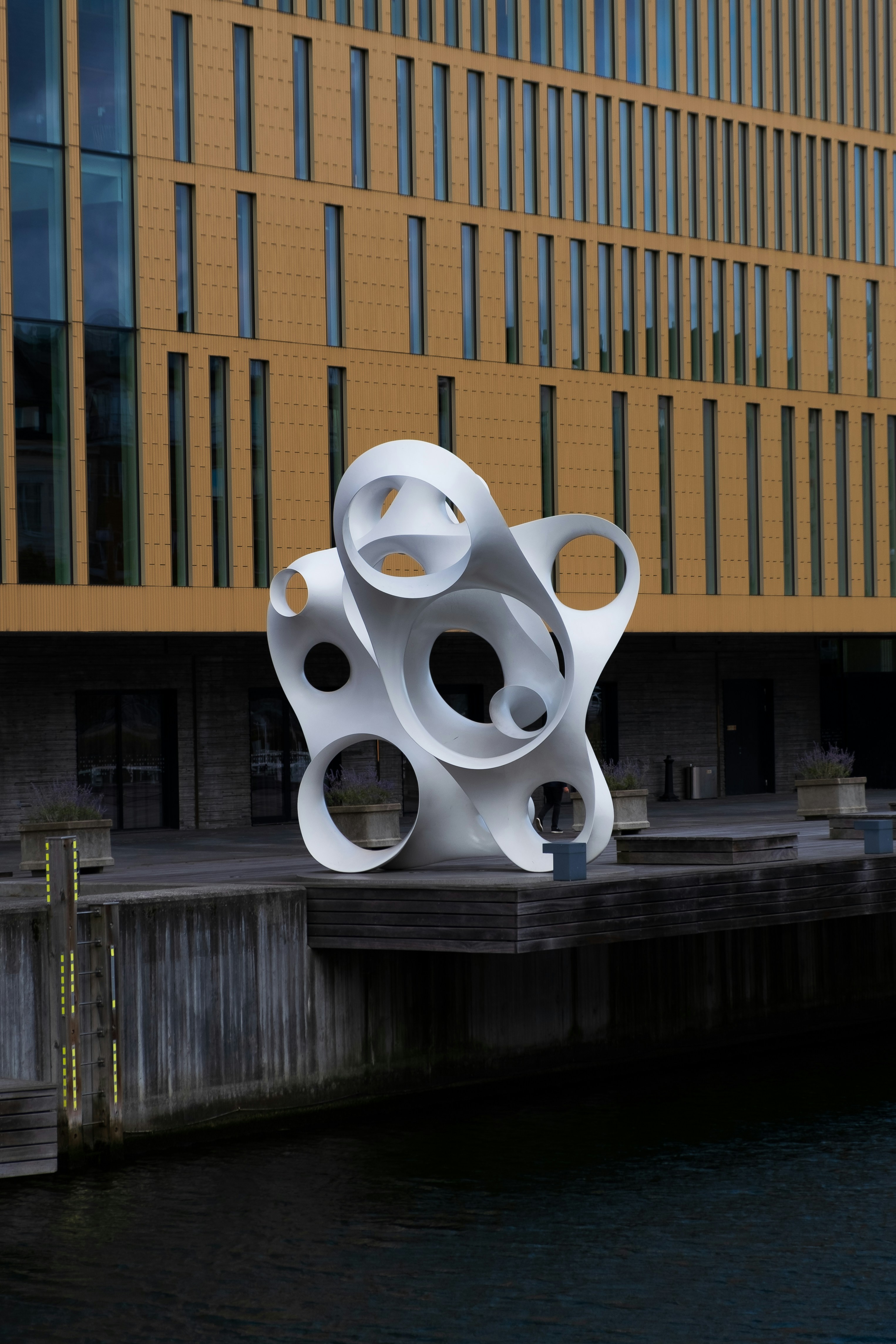 Orbits at the Dock: White Geometry Against a City Grid