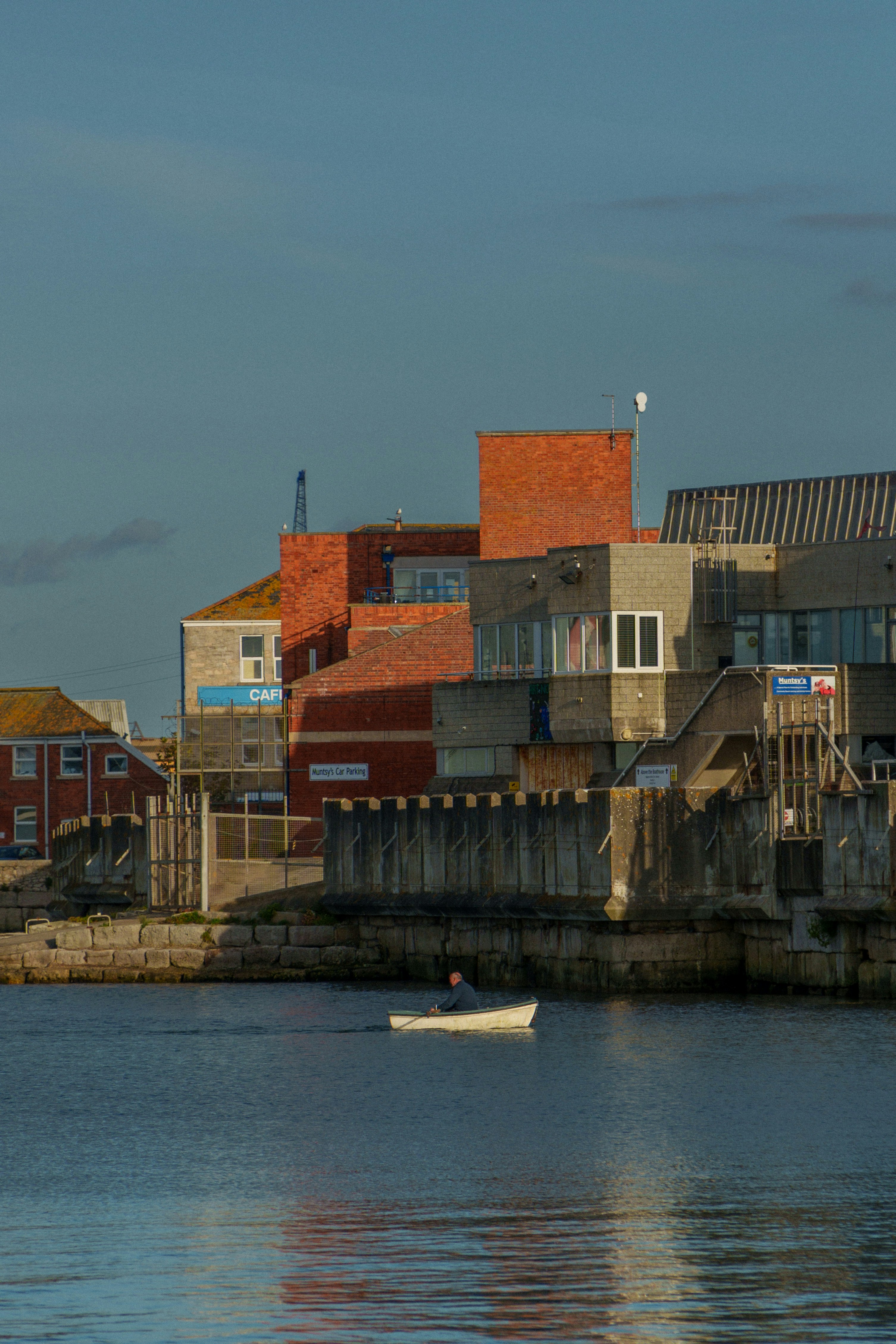 Harbor Portrait: A Quiet Boat Waits Before the Buildings