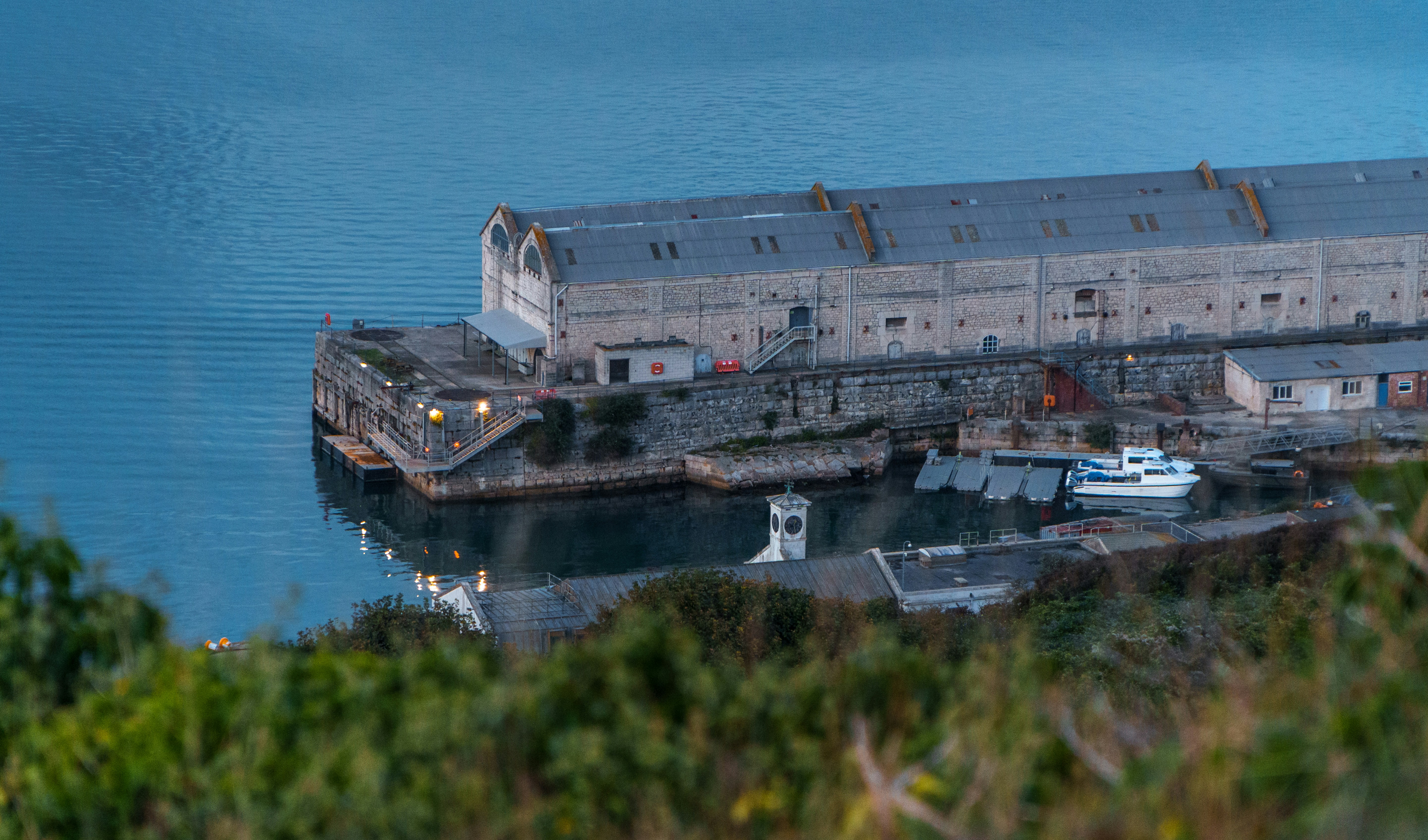 Quayline Echo: Weathered Brick Warehouse Over Calm Waters
