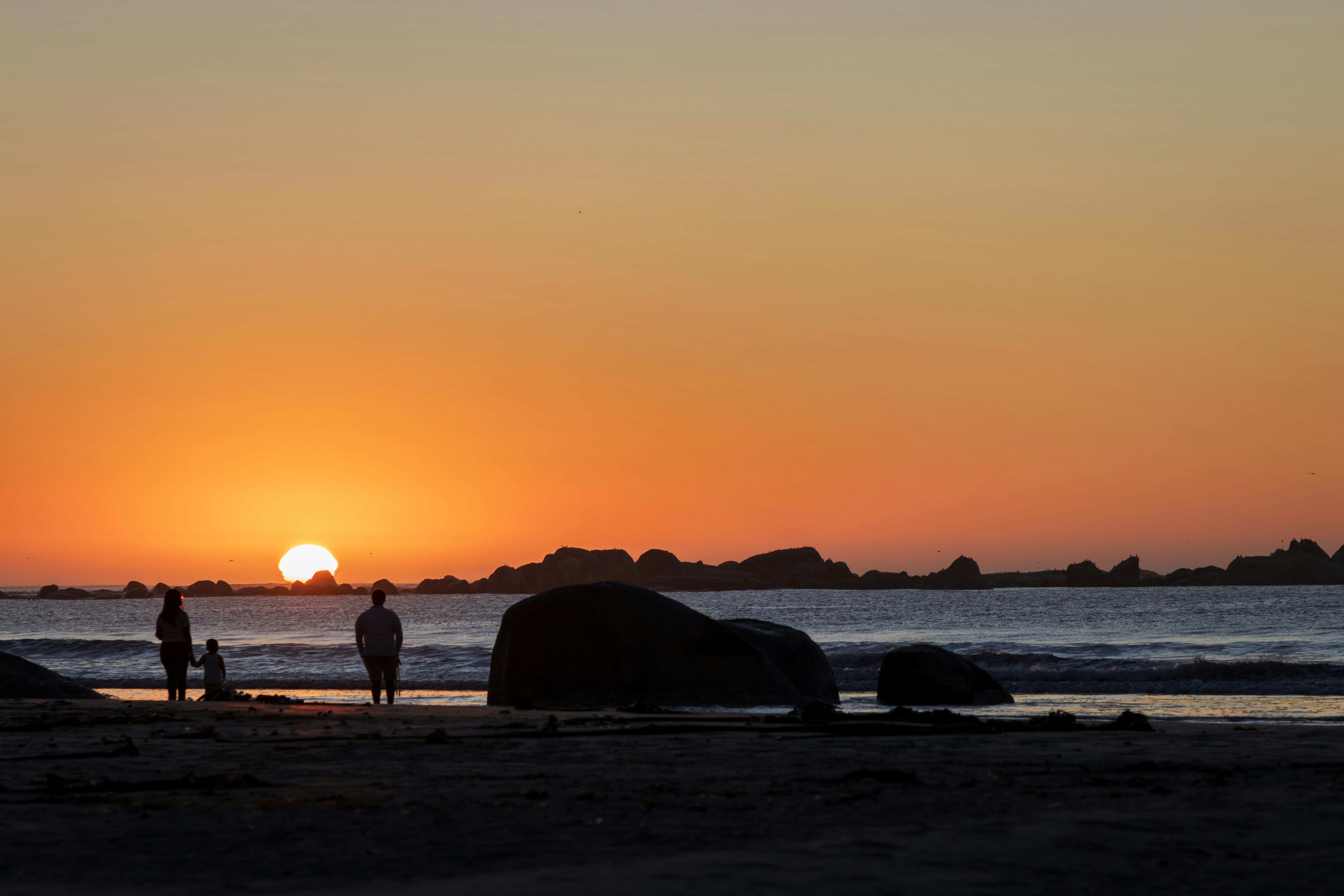 Sunset Silhouettes Over a Rugged Shoreline