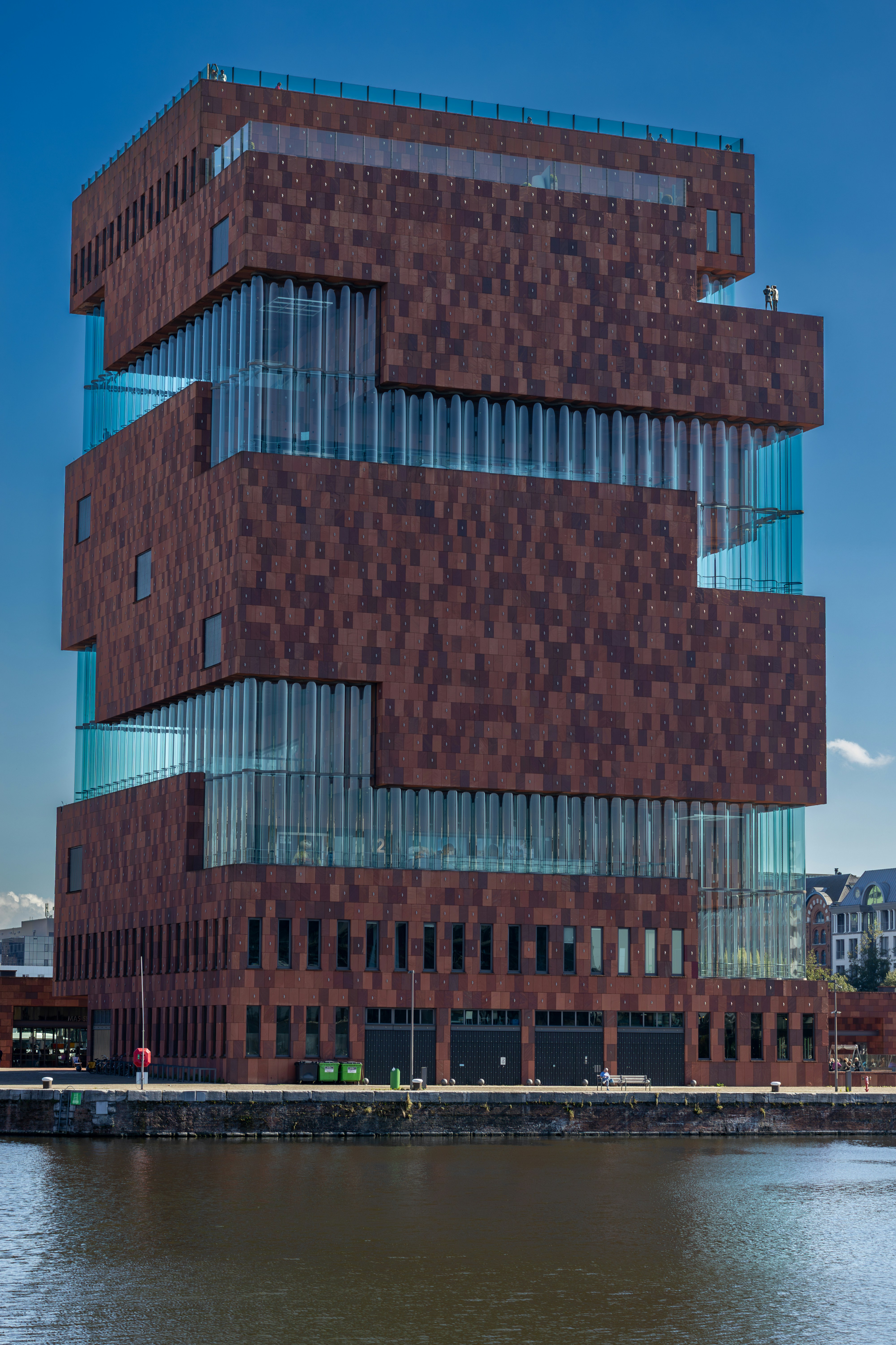 A tall brick building sitting next to a body of waterHendrik Prinsloo