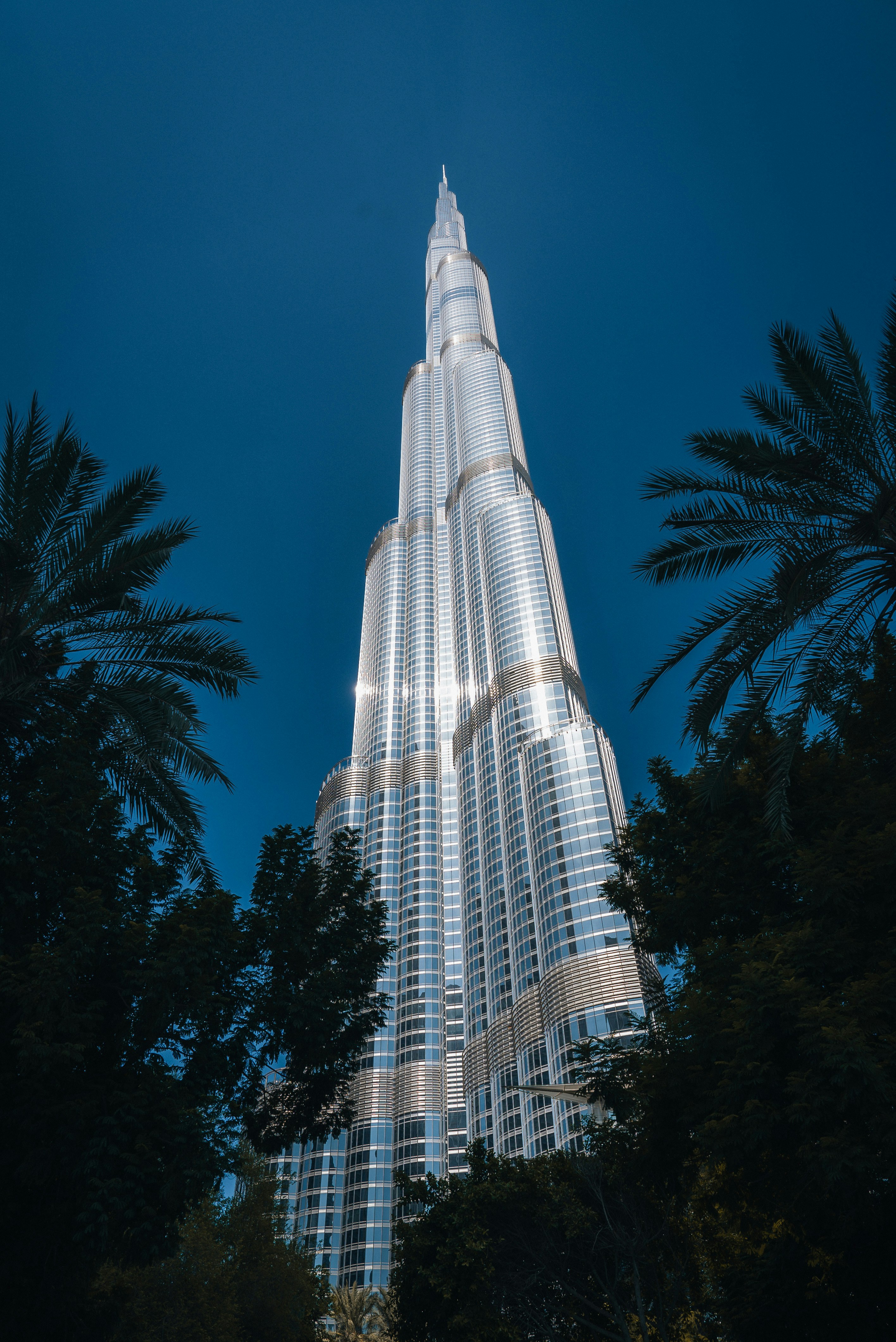 The burj building is lit up at night photo – Free Dubai Image on Unsplash