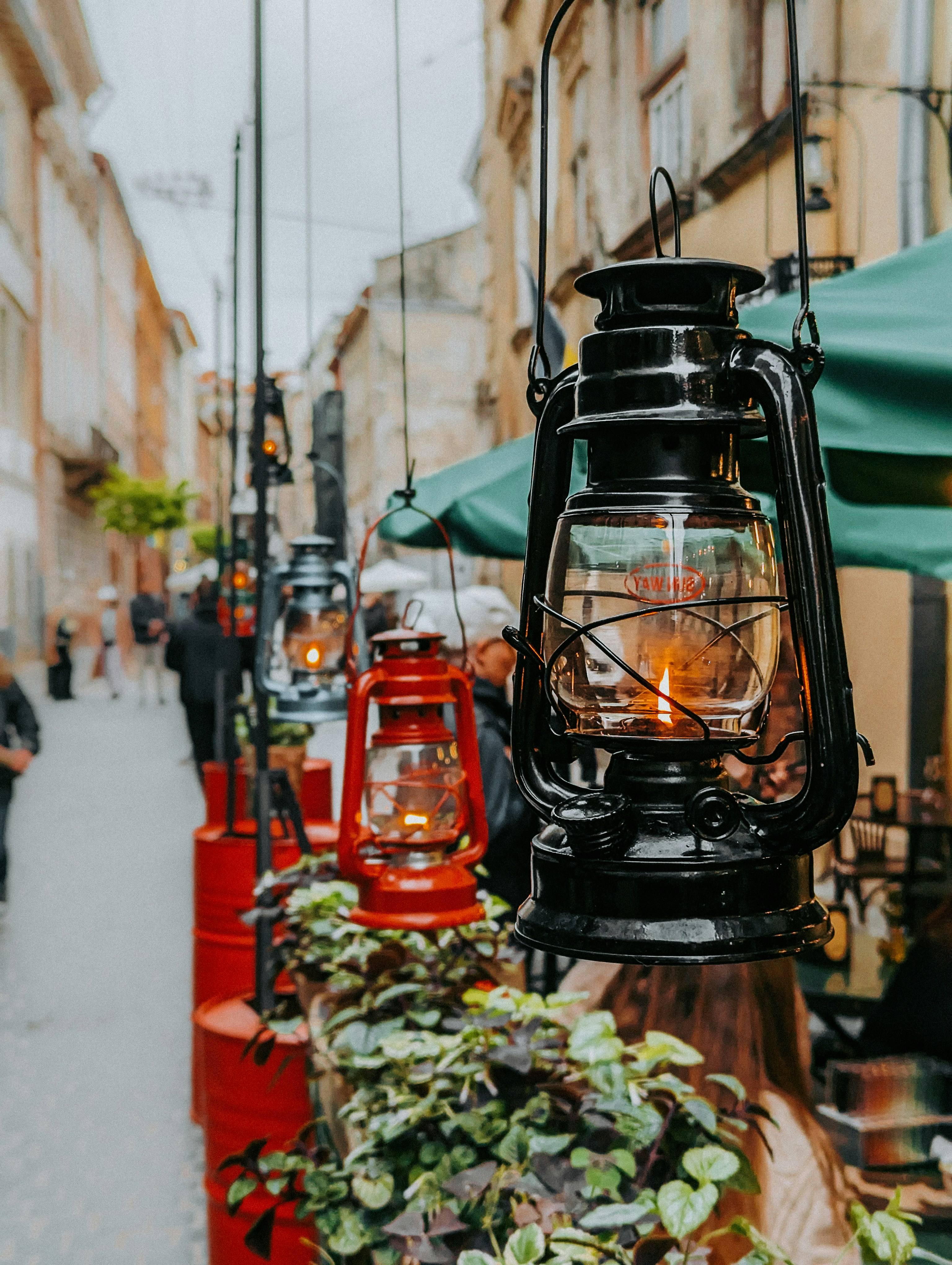 Lanterns Along a Cobblestone Street: Warm Glow by a Quiet Café