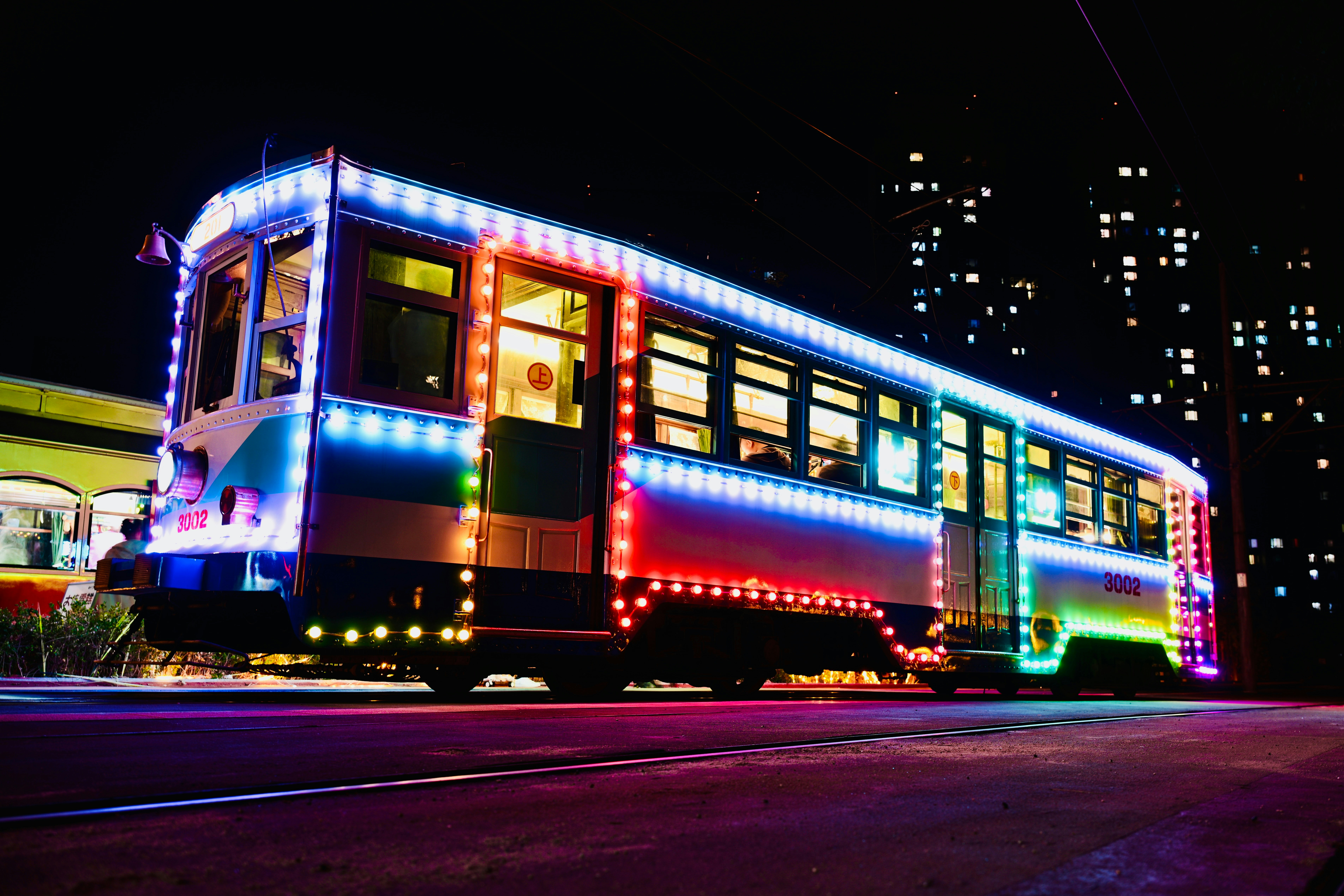 A trolley car with christmas lights on the side of it photo – Free ...
