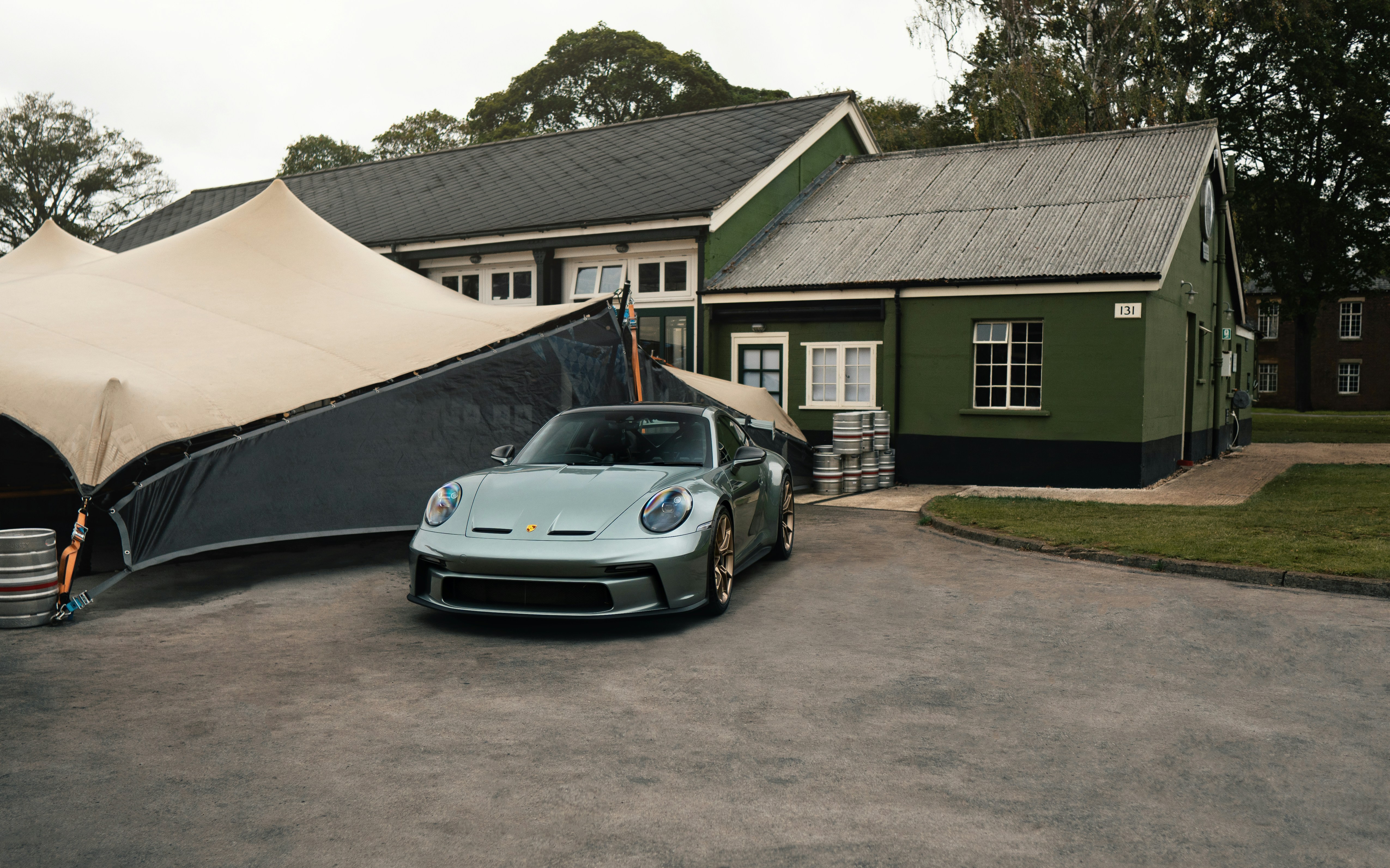 A car parked in a parking lot next to a tent photo – Free Bicester ...