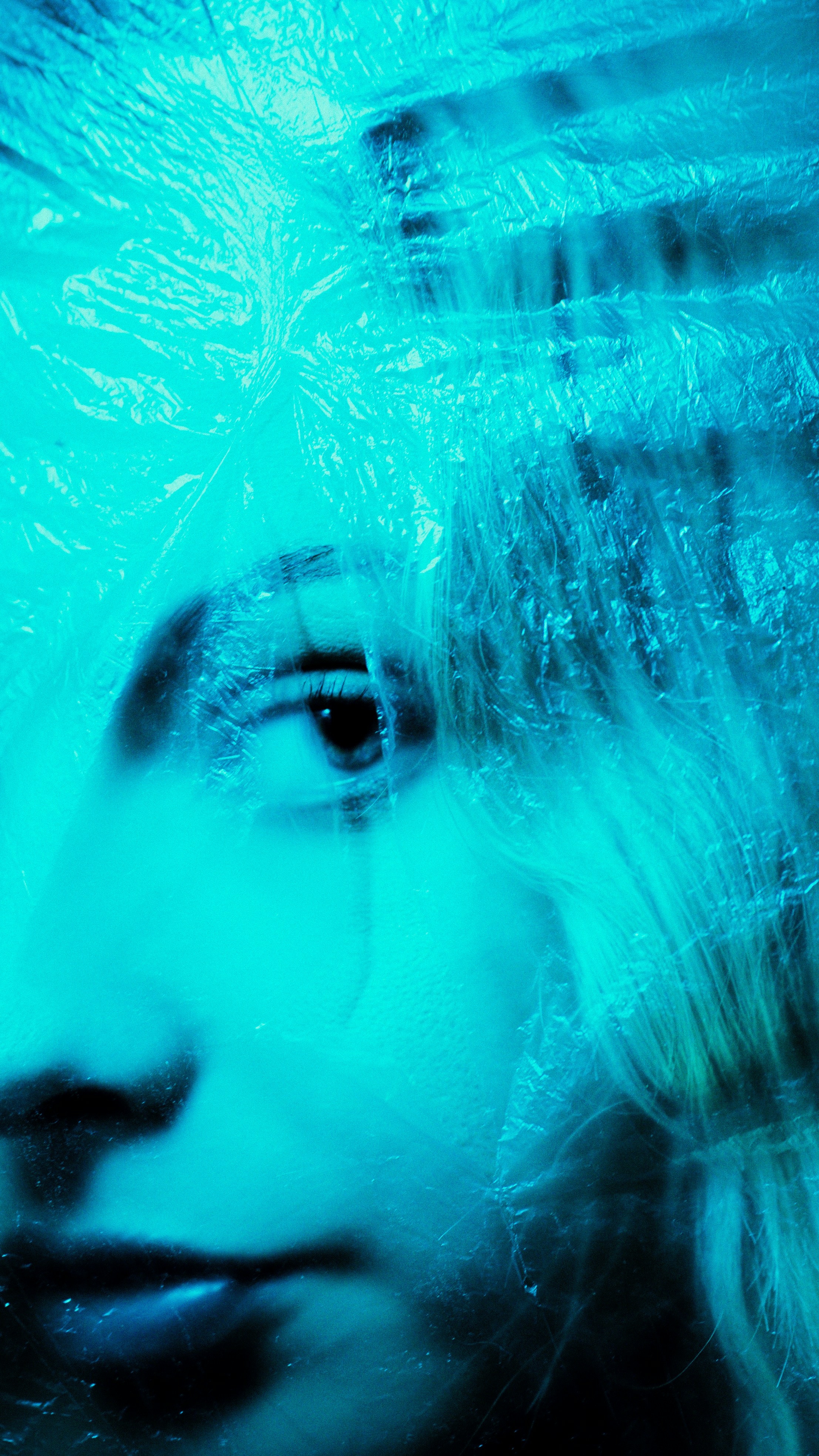 Ice-Clear Gaze: Portrait Behind a Veiled, Cyan Frost