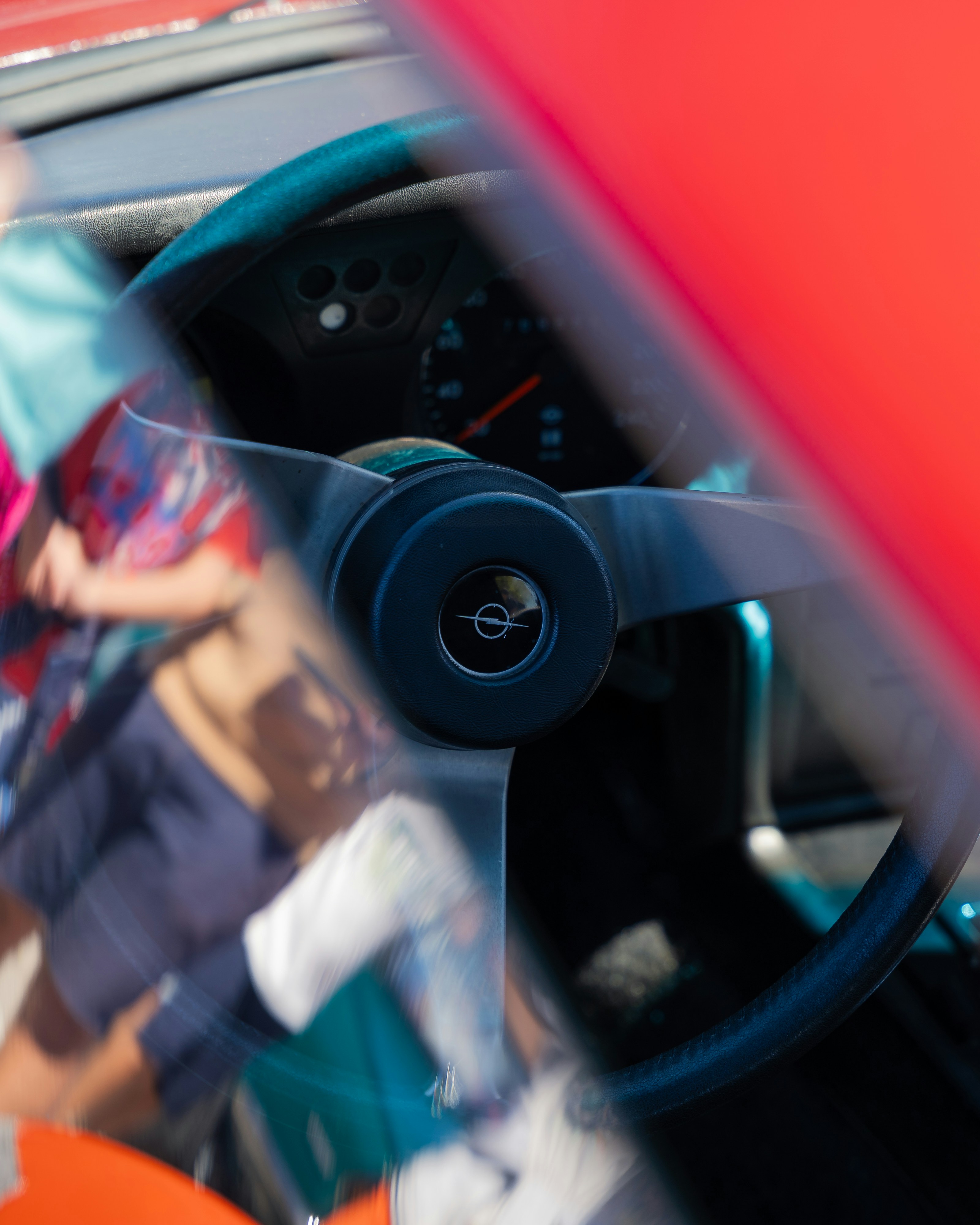 Steering Wheel Moment: Reflections in a Red Car Cabin