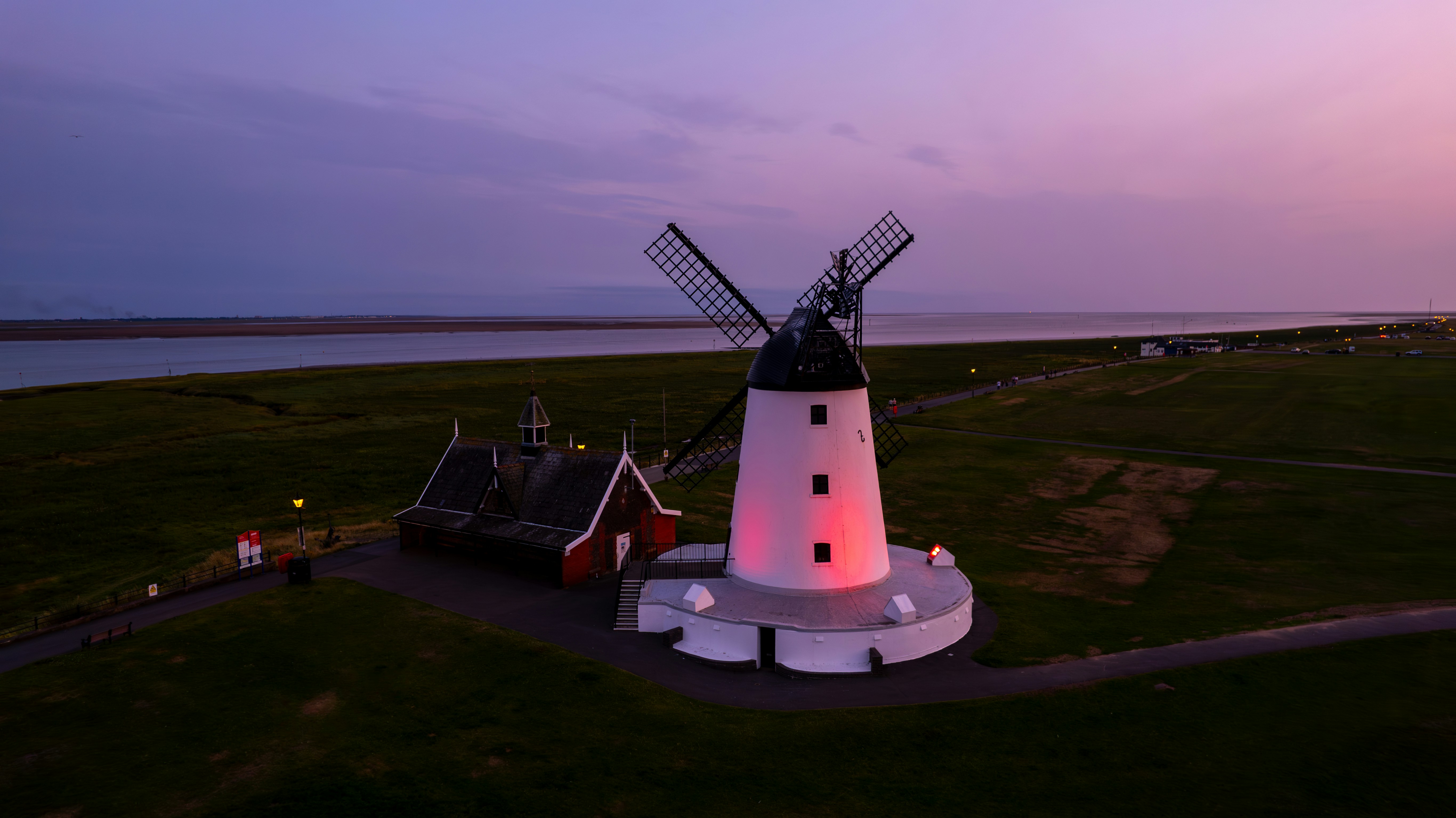 A windmill sitting on top of a lush green field photo – Free Lytham ...