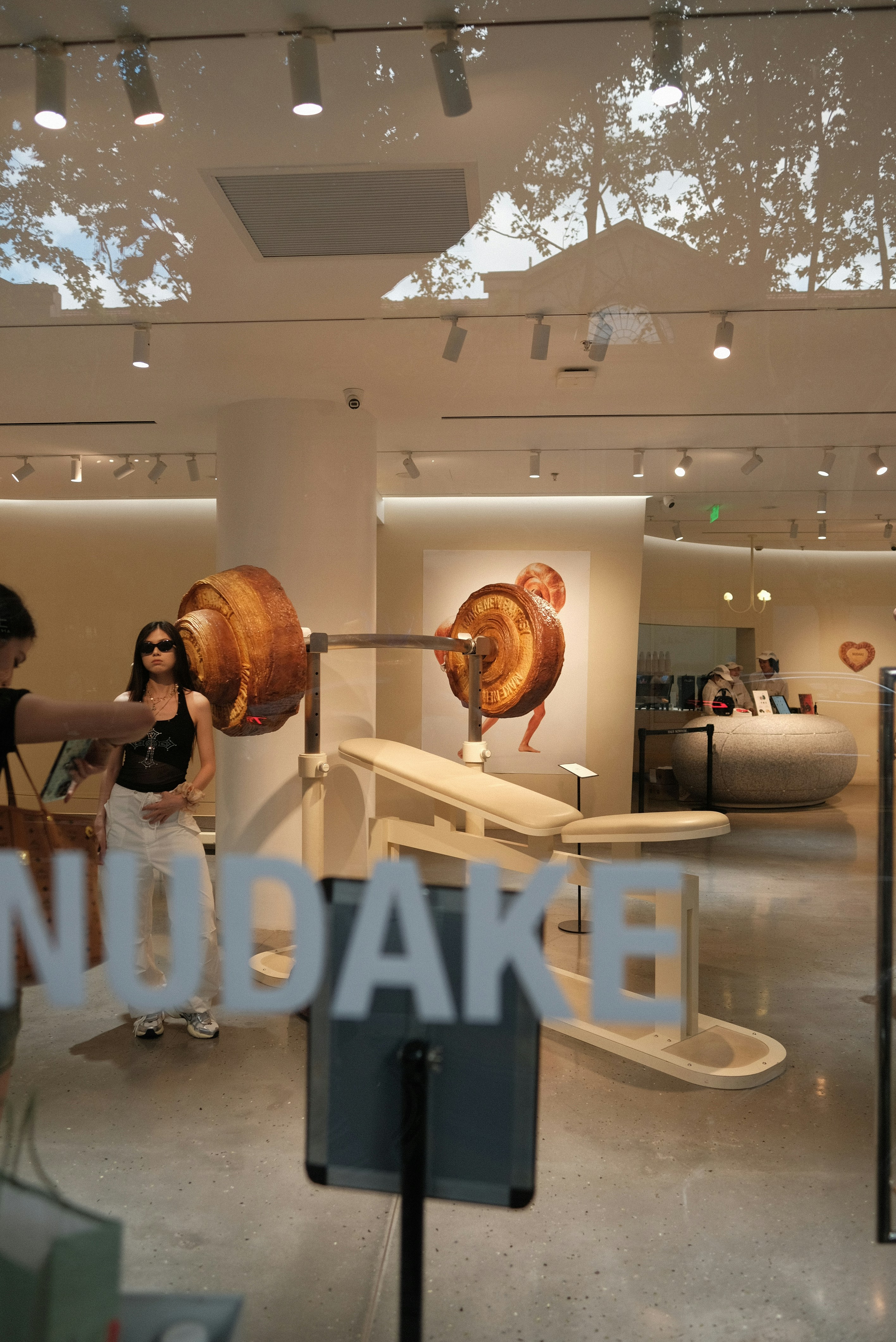 A woman taking a picture of a display in a museum