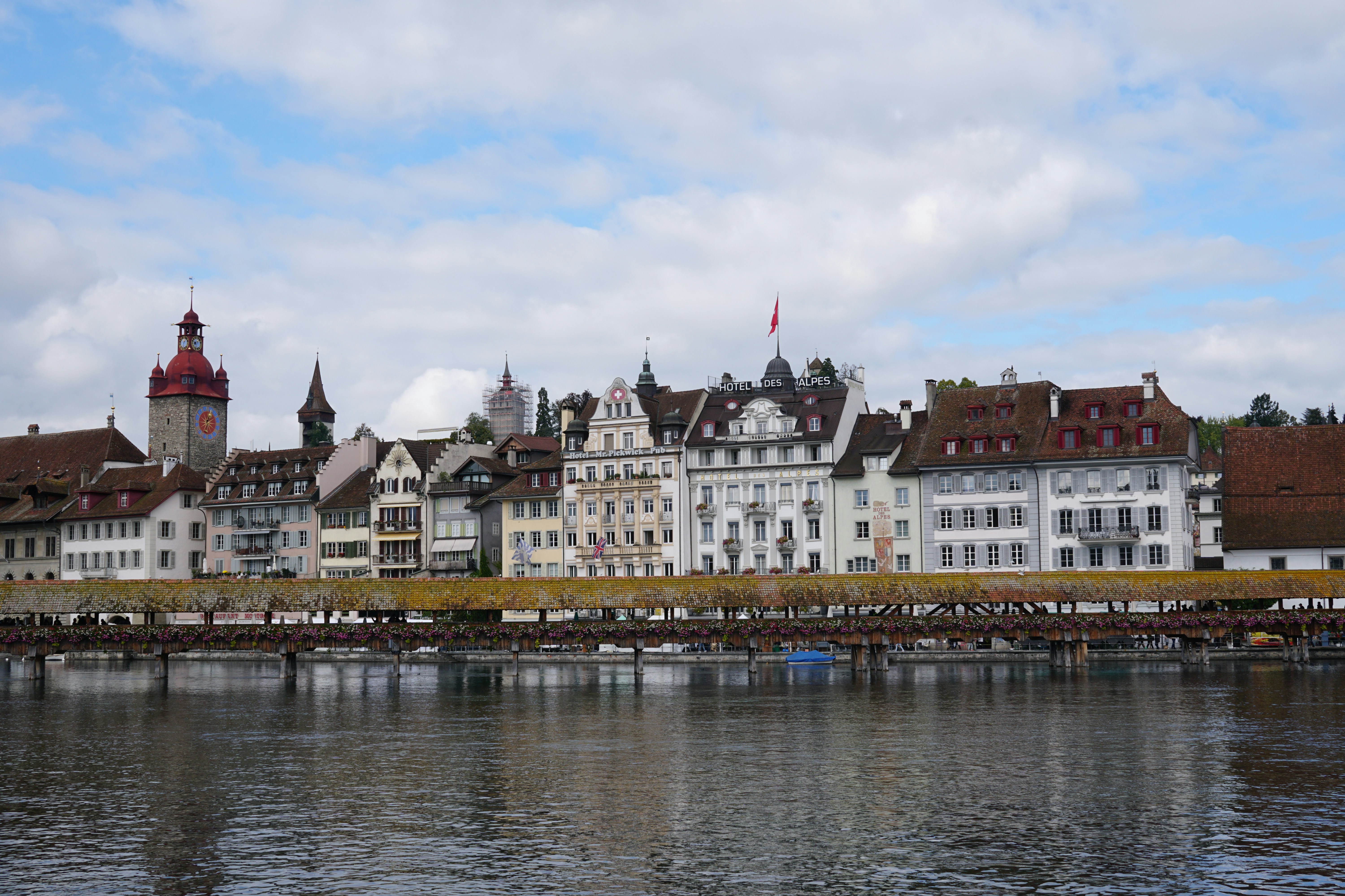 Echoes of Color Along the River: Riverside Townhouses Reflect in Calm Waters